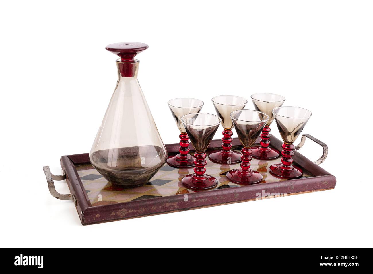Tray with antique alcohol glasses and a carafe on a white background ...