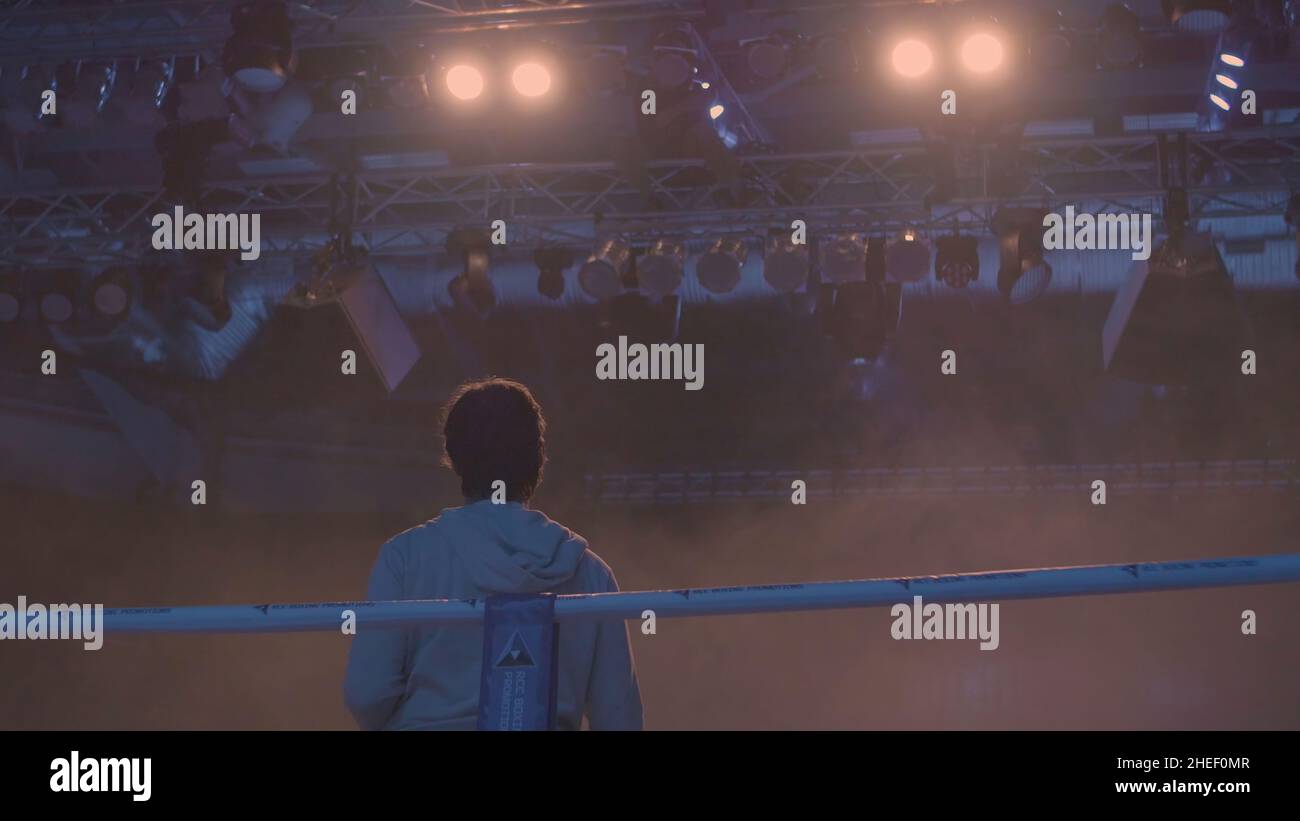 Back view of working gaffer or lighting technician and spotlights ...