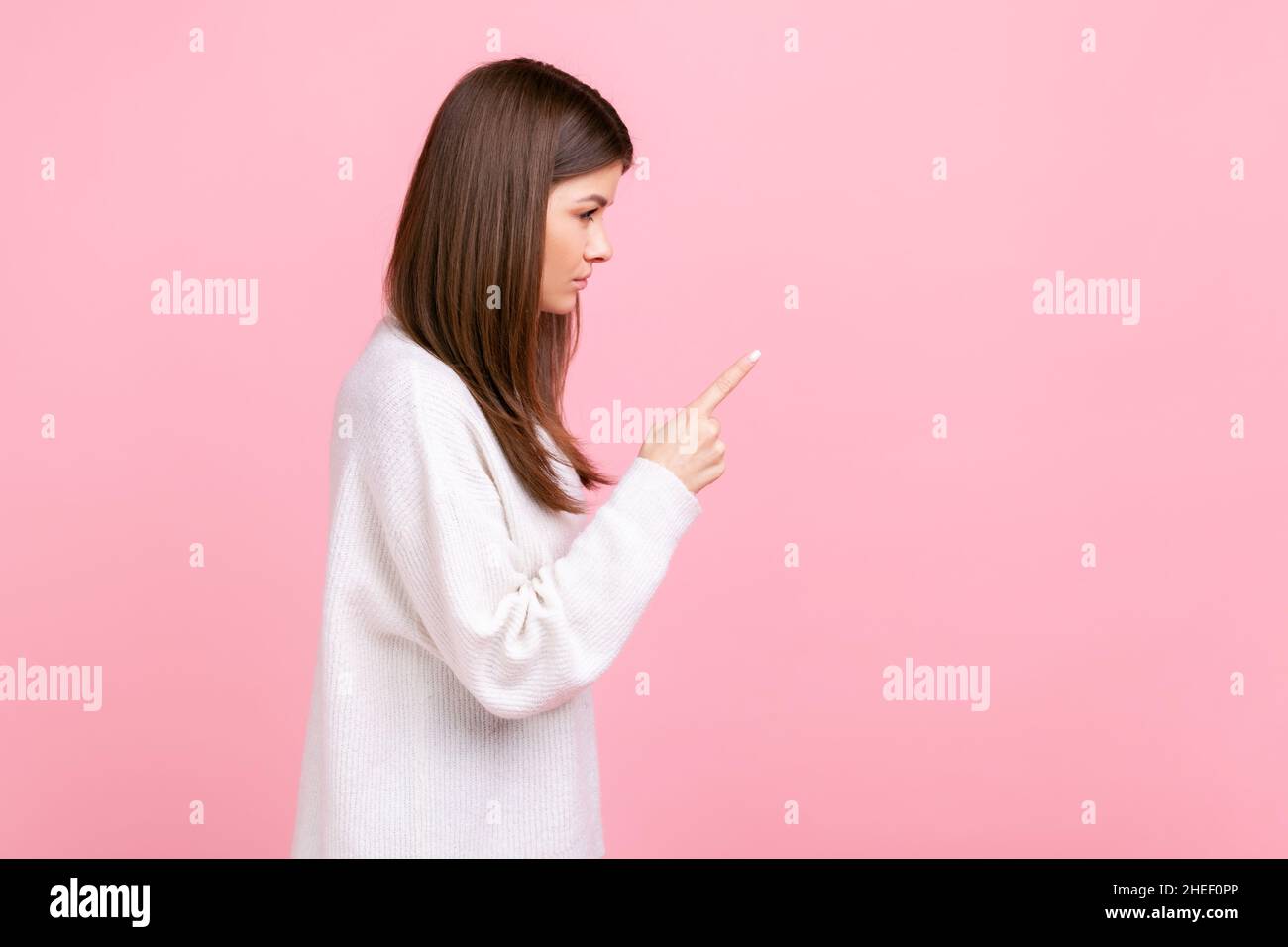 Side view portrait of strict female with raised finger, showing warning ...
