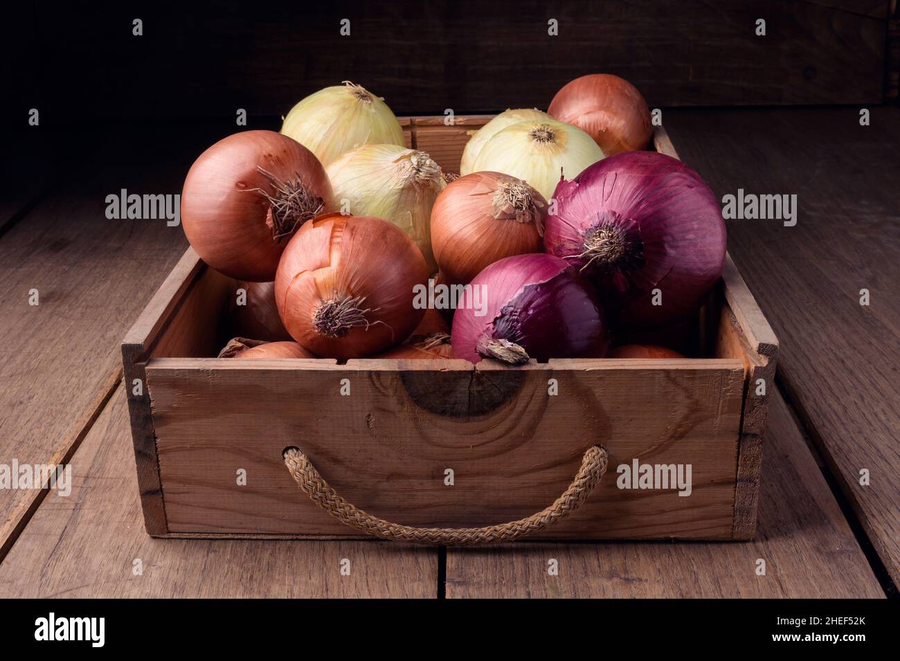 Onions in old box on rustic wooden table, food ingredients Stock Photo ...