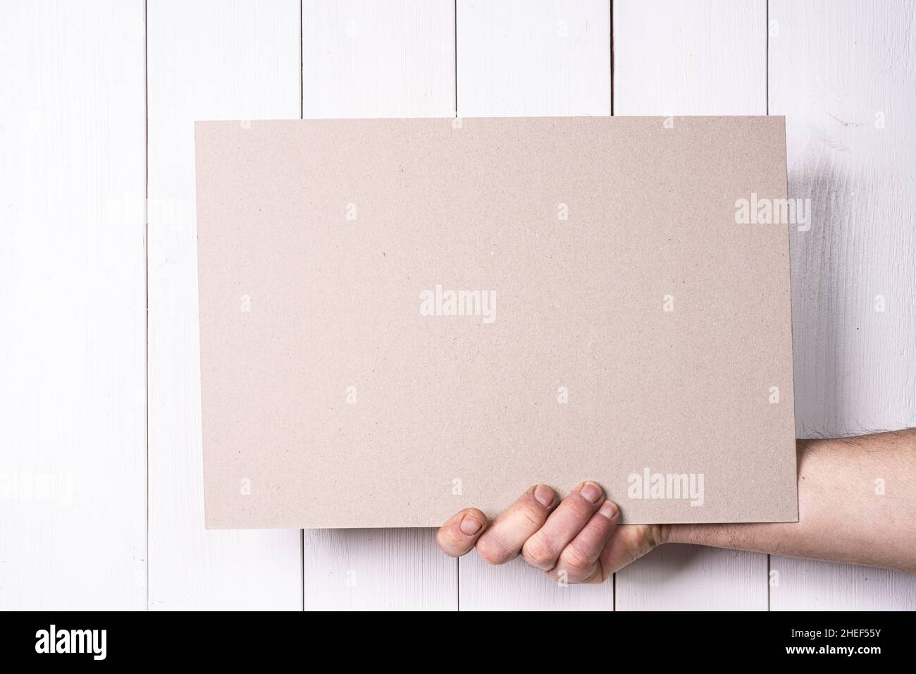 a cardboard sign held in hand Stock Photo - Alamy