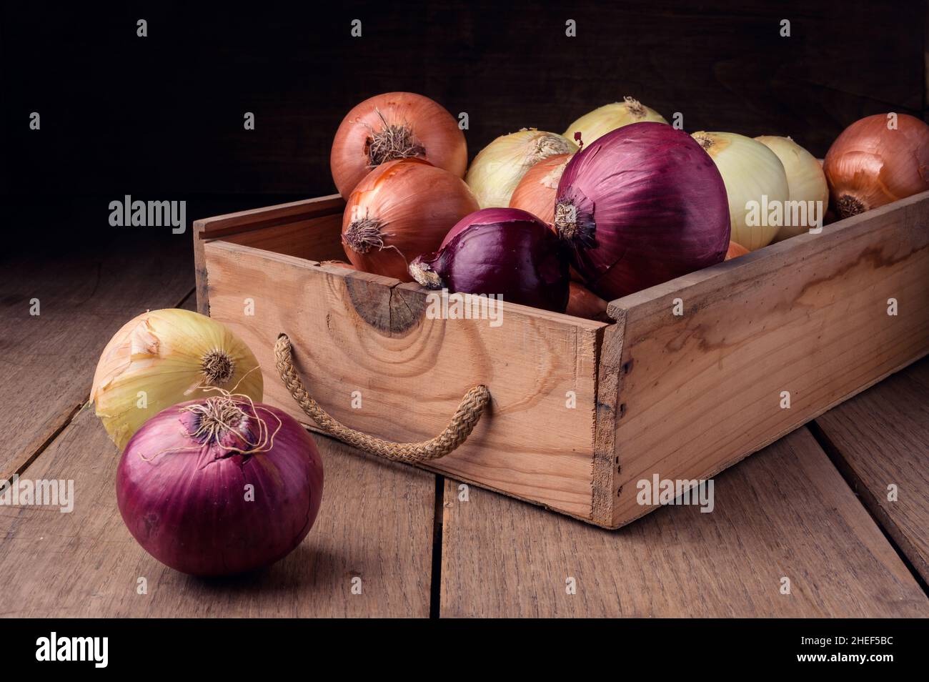Onions in old box on rustic wooden table, food ingredients Stock Photo ...