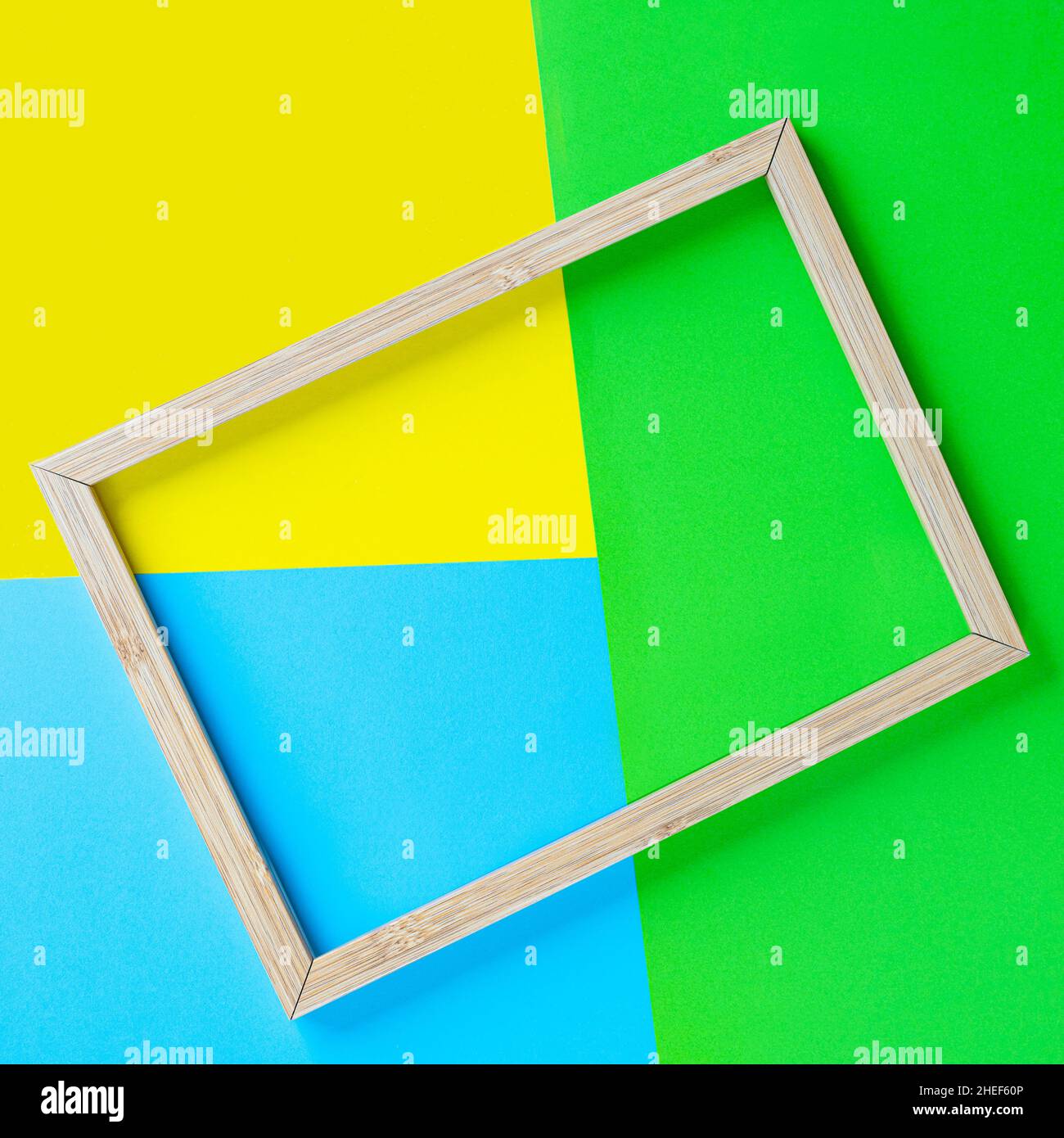 a wooden frame on a background of colored shapes Stock Photo - Alamy
