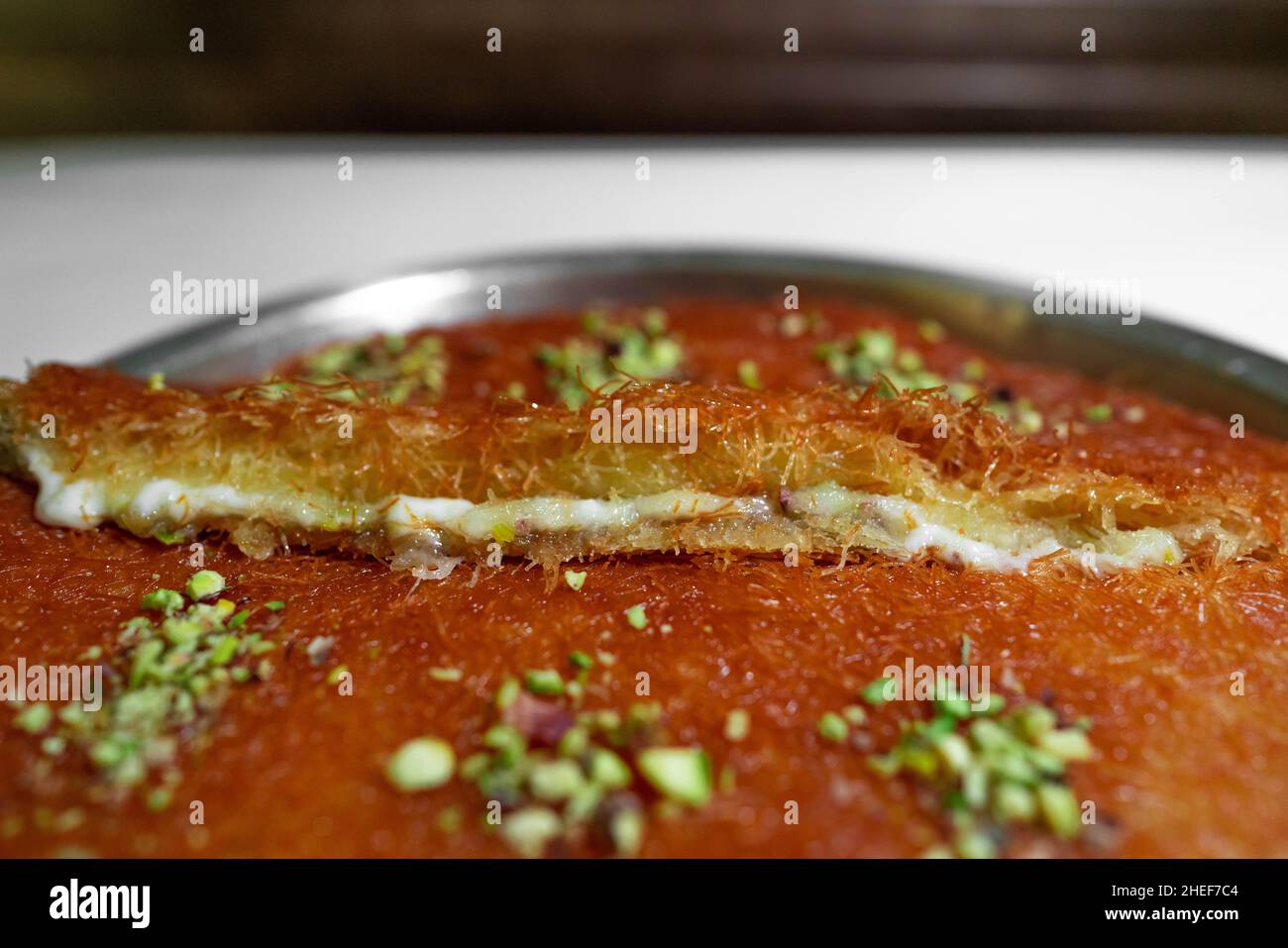 Arabic traditional dessert - kunafa - konafa in a tray with pistachio ...