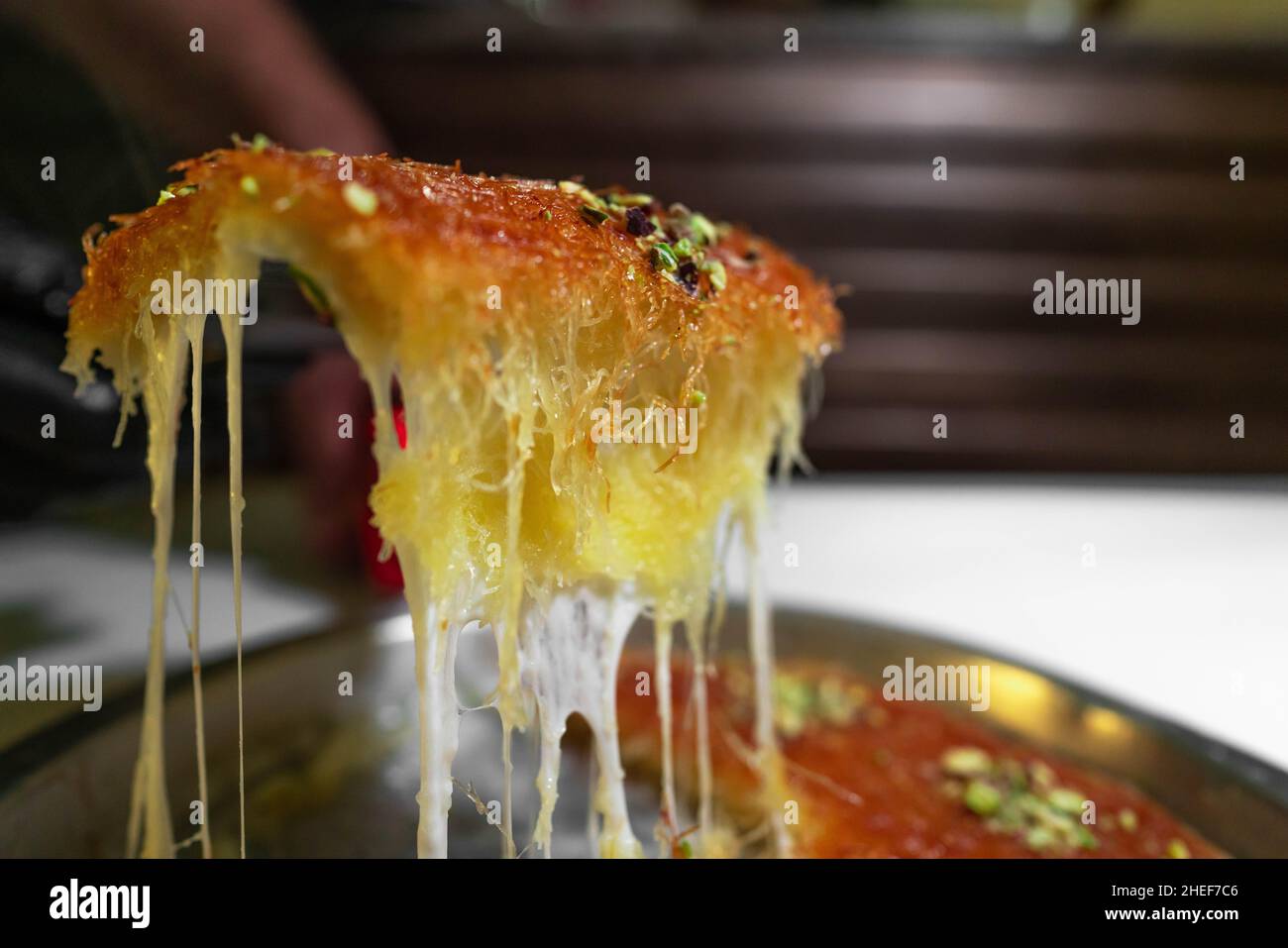 Arabic traditional dessert - kunafa - konafa in a tray with pistachio ...