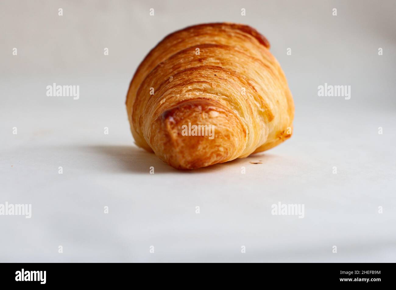 Freshly baked croissant on a parchment paper. Ready to eat puff pastry ...