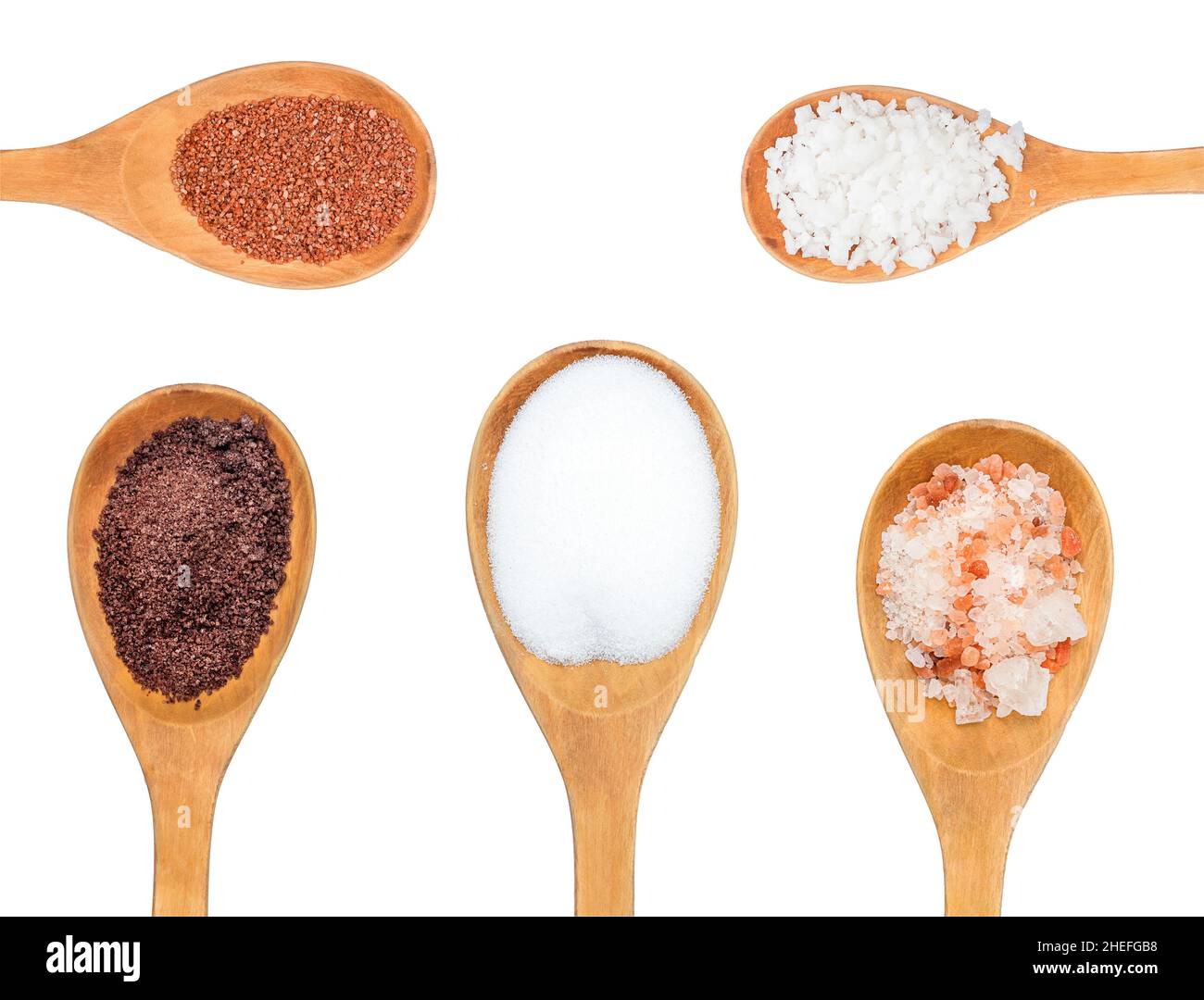 Collection of types of salts in wooden spoons isolated on white ...