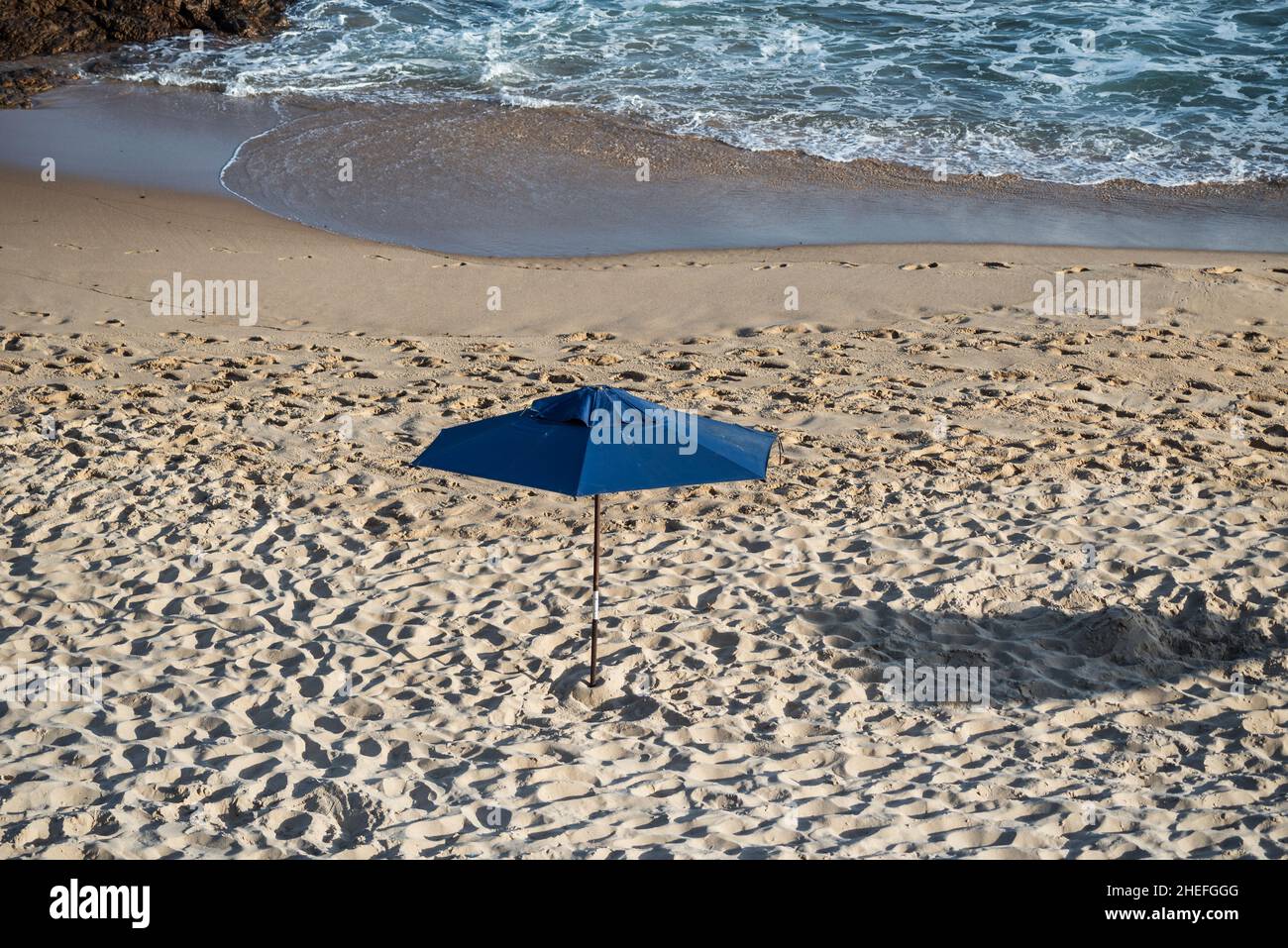 Sunshade on the beach in the strong sun of the day. Paciencia Beach in ...