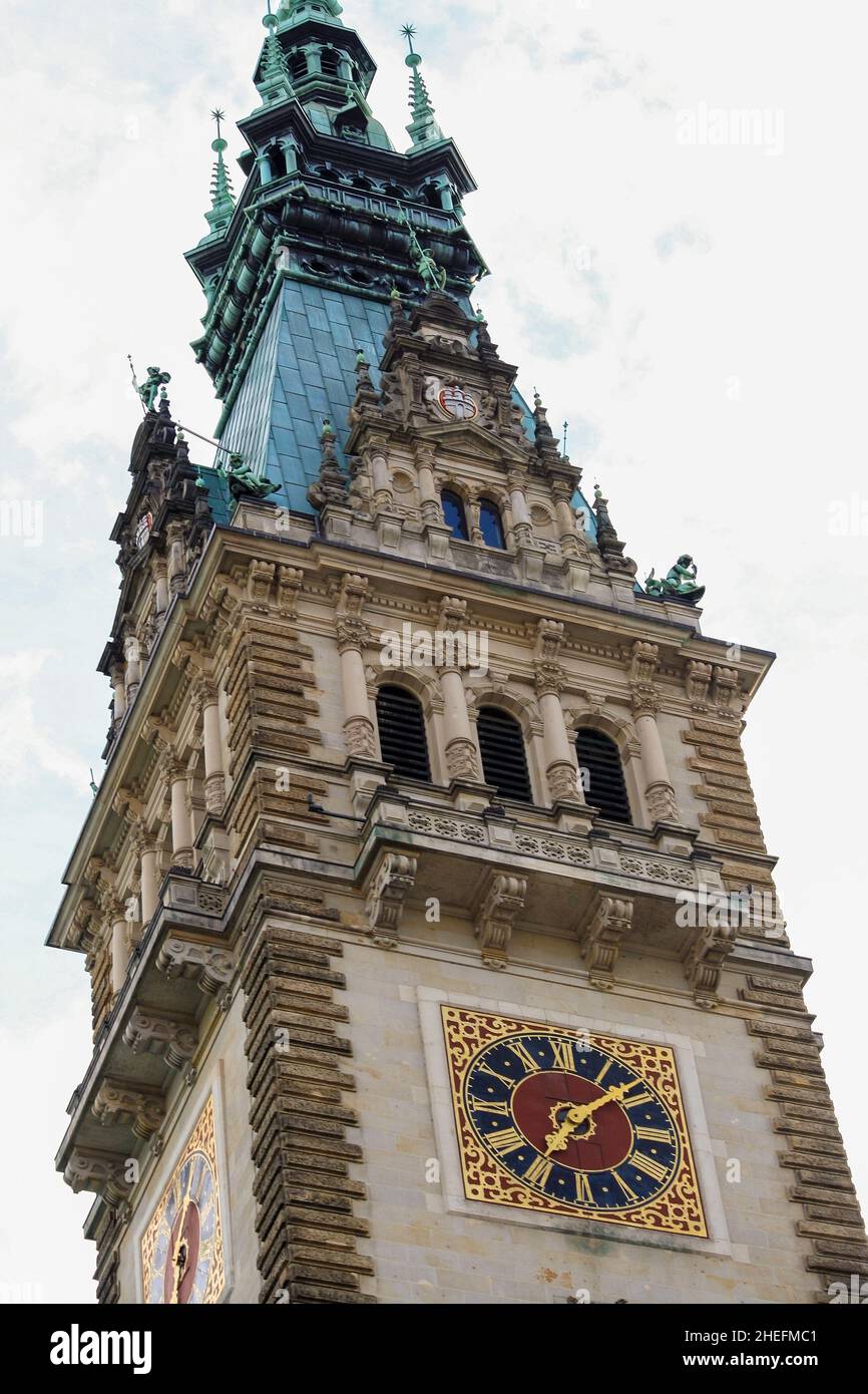 Close up of Hamburg town hall clock tower in summer with clouds in blue ...