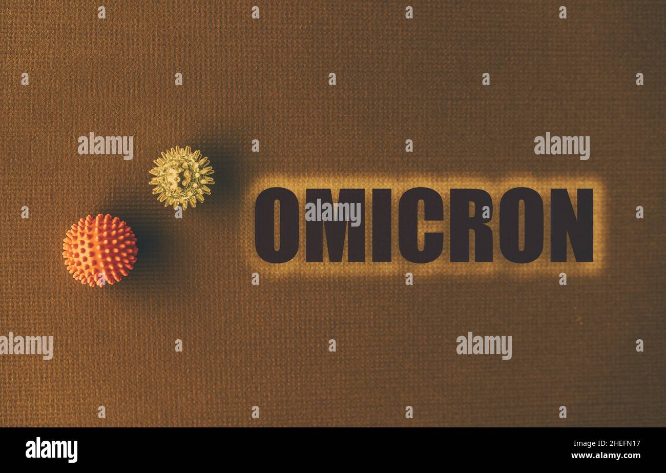 Omicron coronavirus variant sign on orange background with virus sphere ...