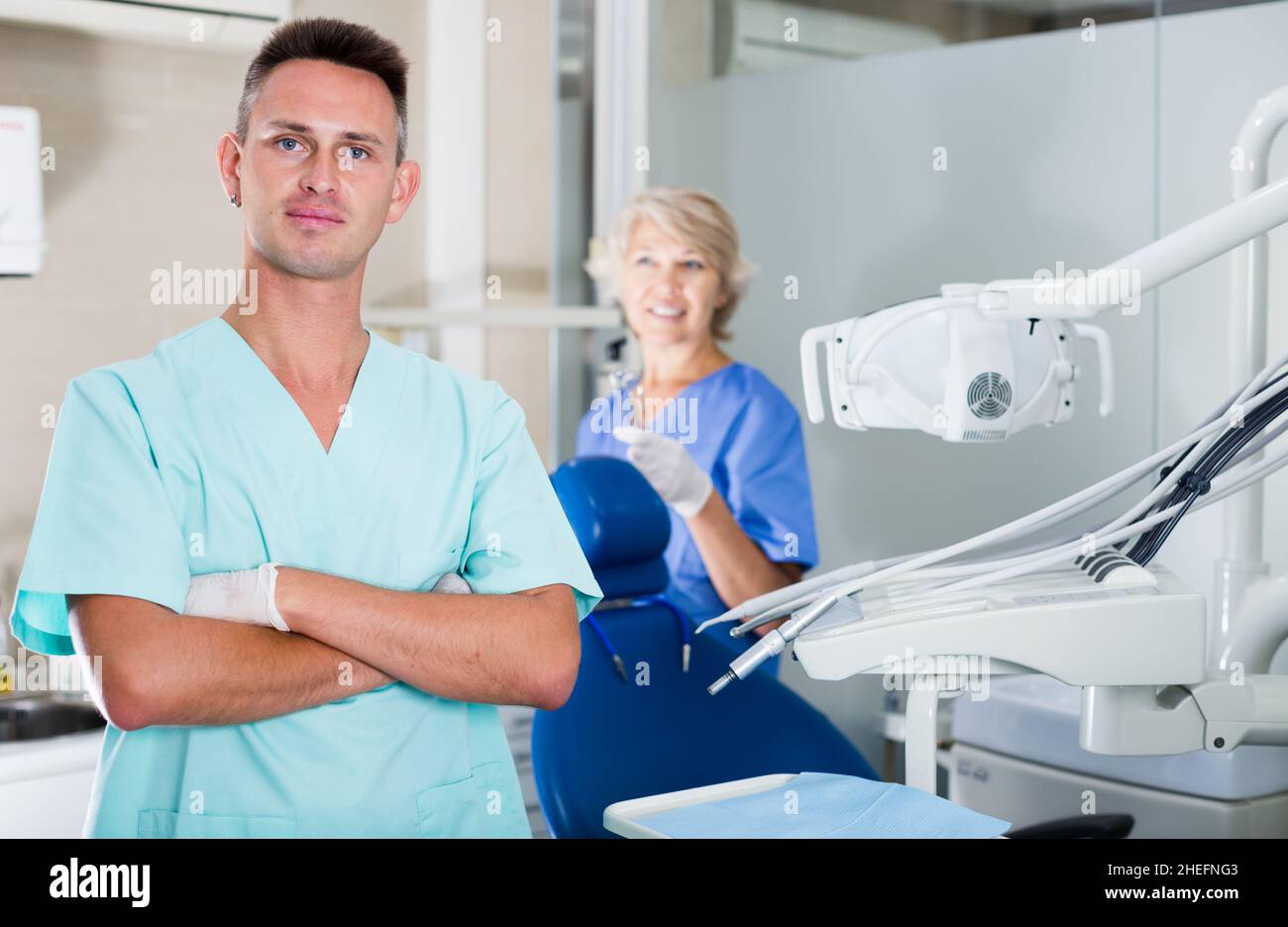 Portrait of male dentist with arms crossed Stock Photo - Alamy