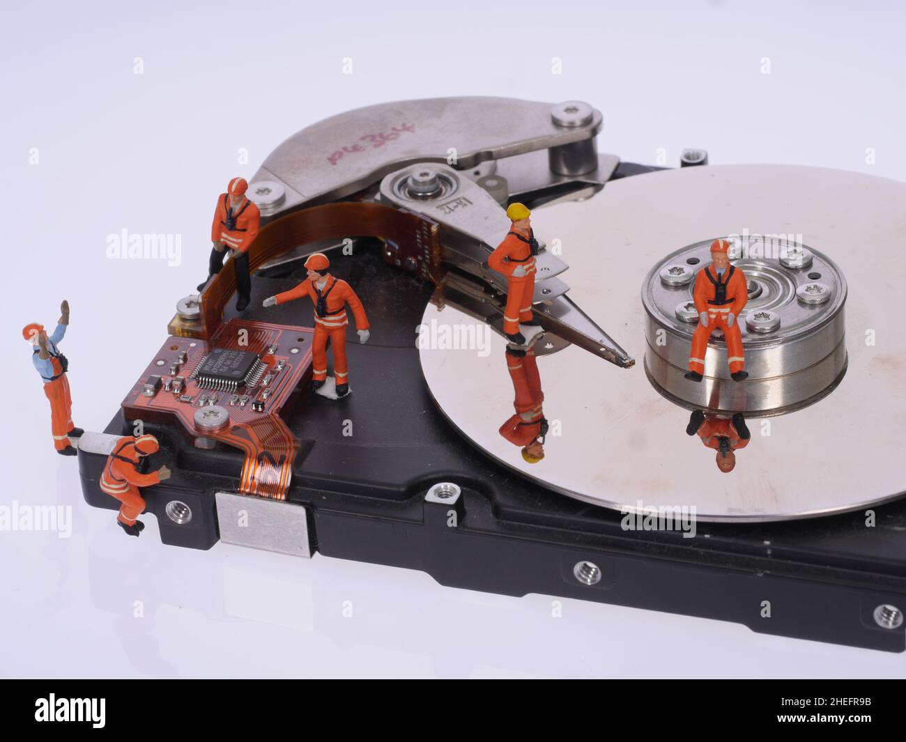 hard disk with tiny humans Stock Photo - Alamy