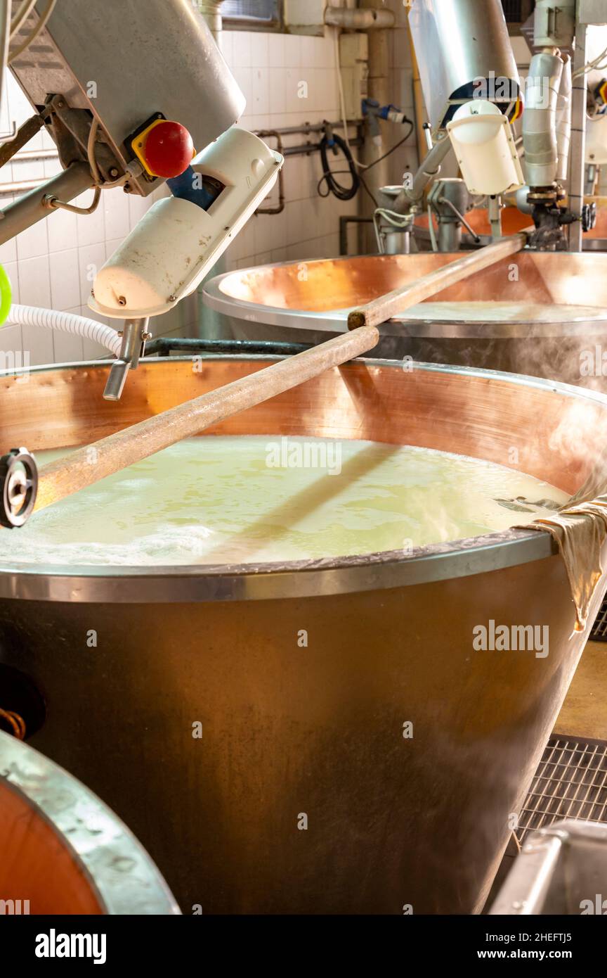 Traditional process of making wheels of parmigiano-reggiano parmesan ...