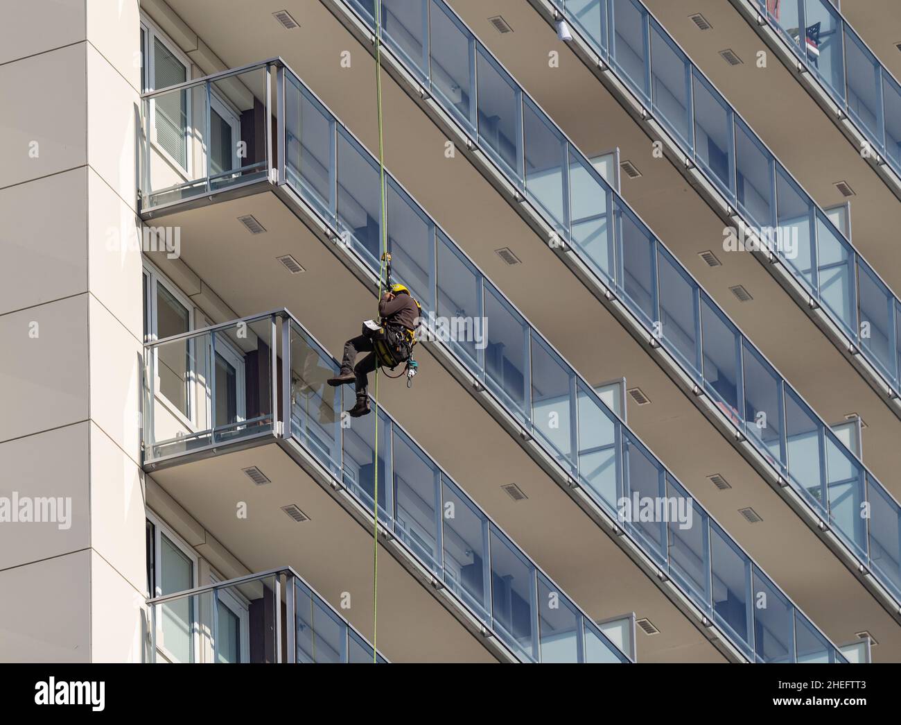A man cleaning windows on a high rise building in White Rock BC, Canada ...