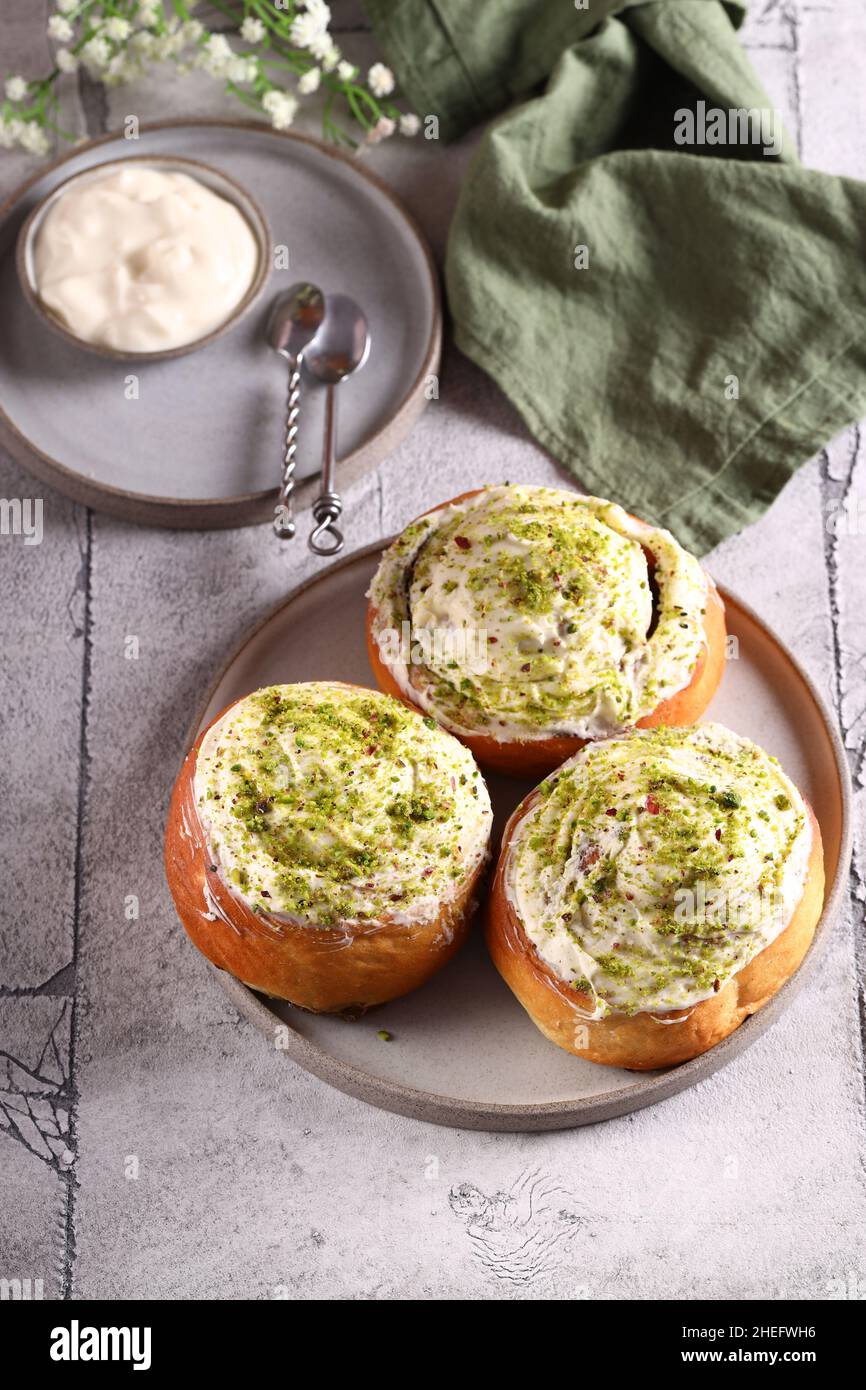 traditional cinnamon buns with icing Stock Photo - Alamy