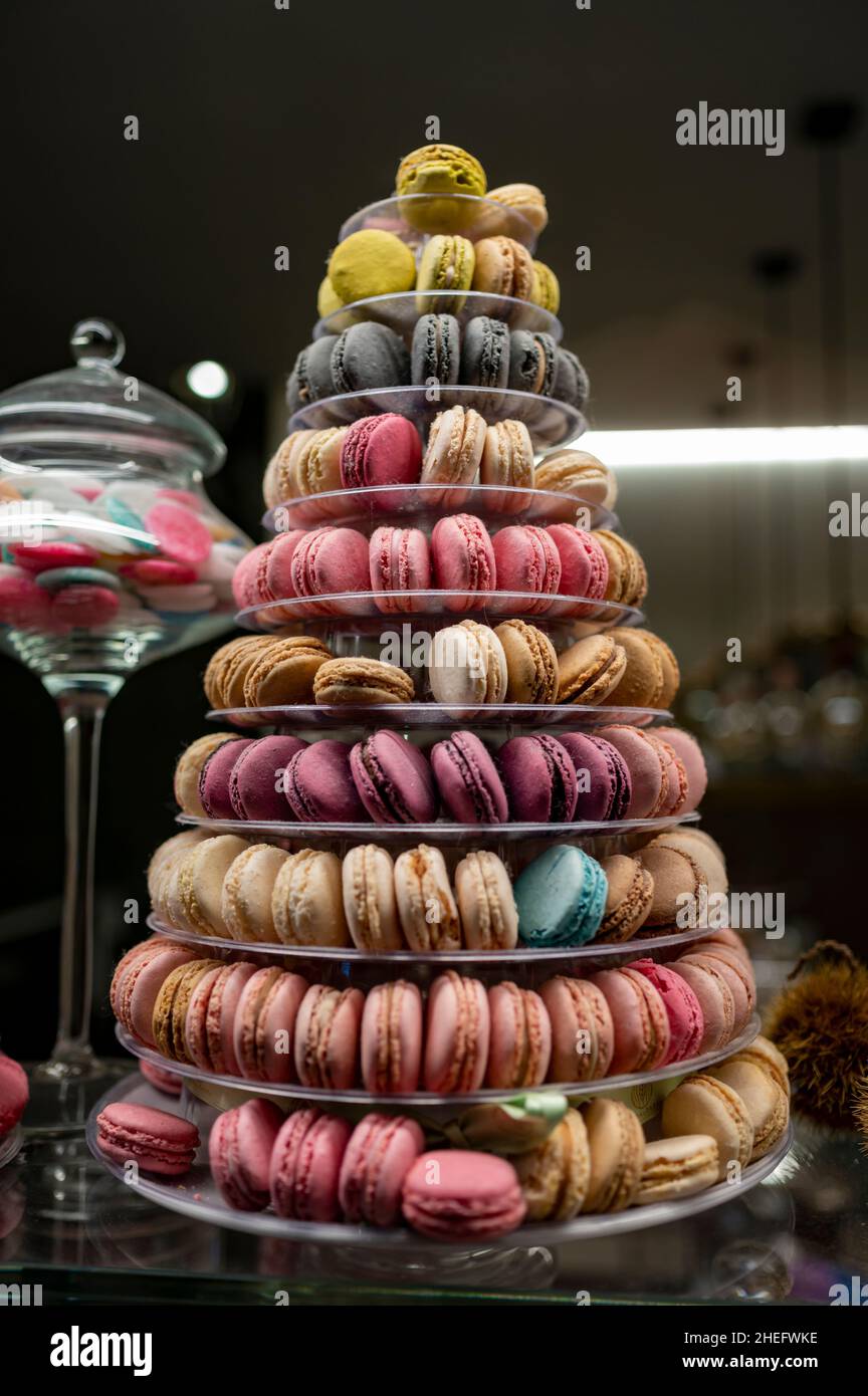 Candy shop display with colorful pyramid of French macarons biscuits at ...