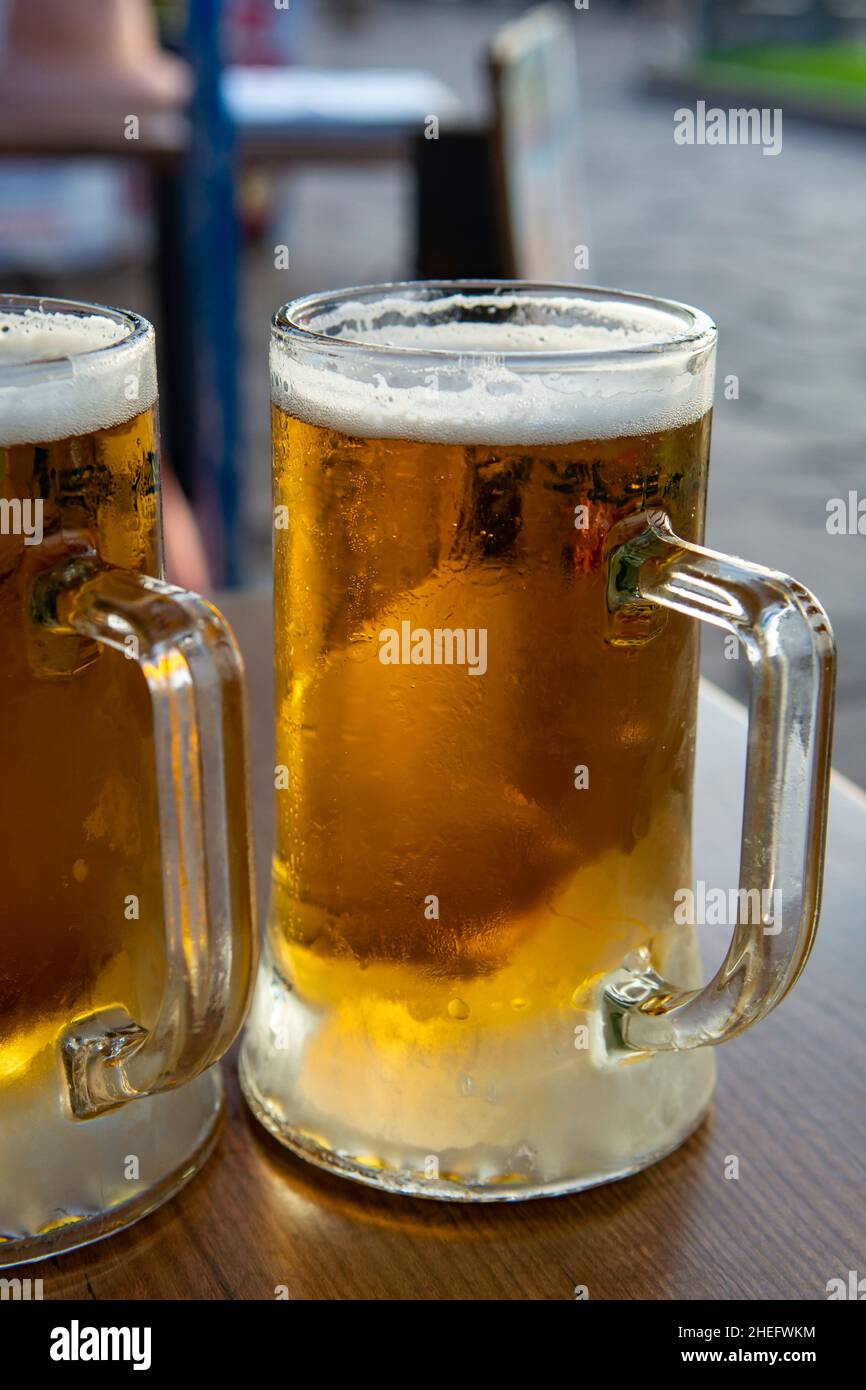 Two pint glasses with cold beer served outdoor on sunset Stock Photo ...