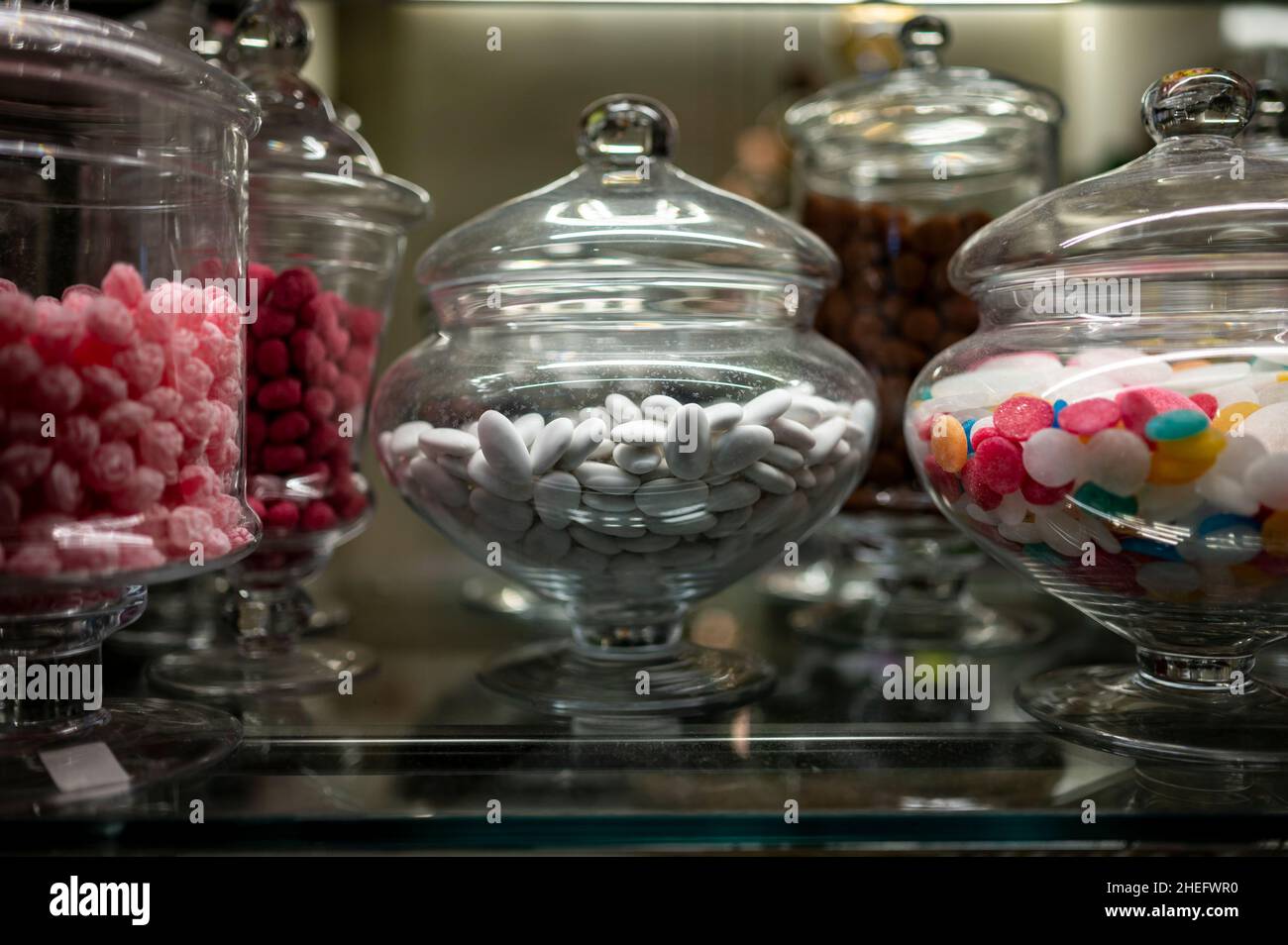 Candy shop display with glass jars filled with jelly candies and ...
