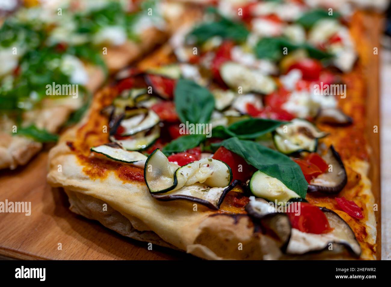 Fresh baked focaccia or pala romana pizza with vegetables and cheese in ...