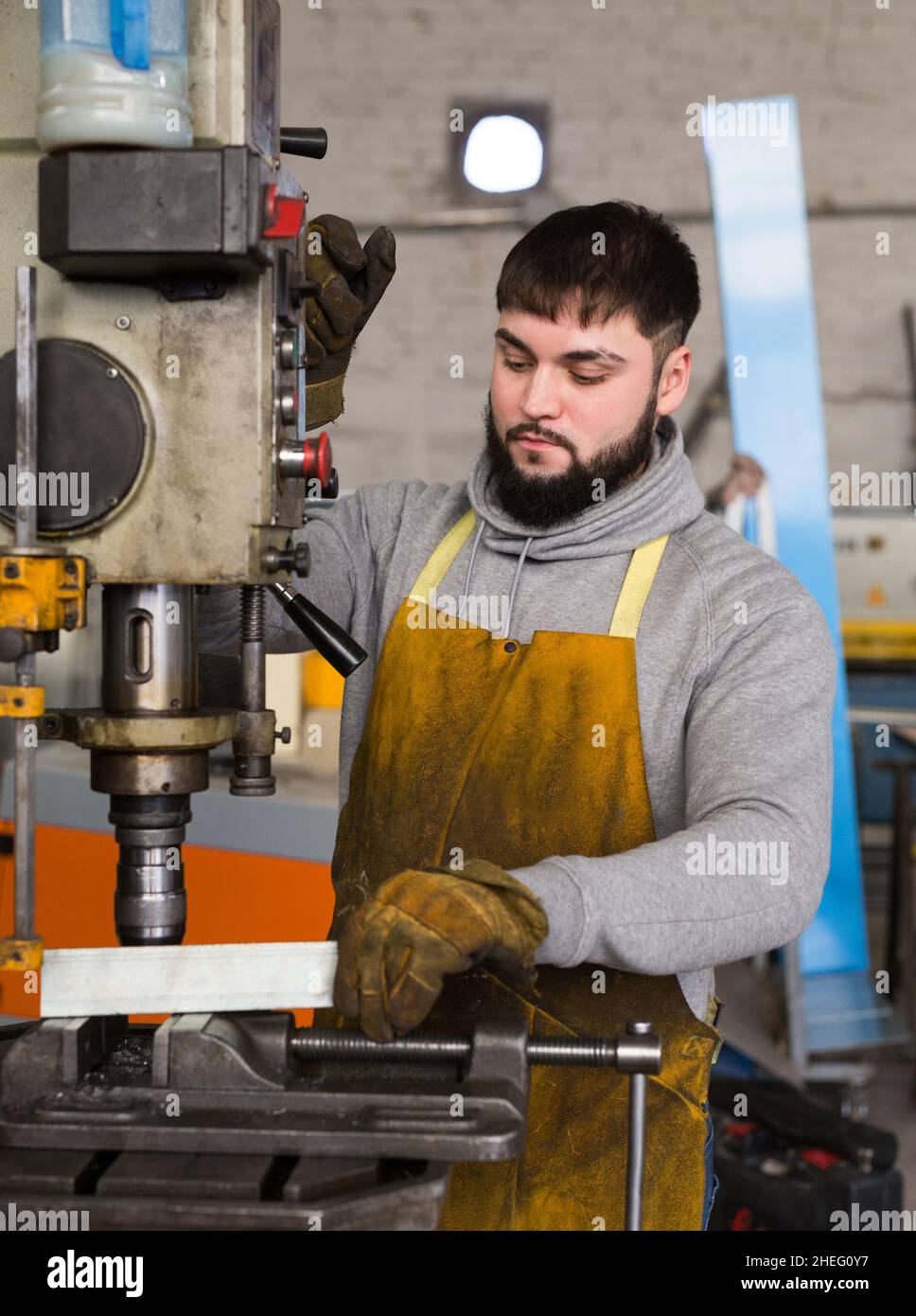 Craftsman working on metal structures drilling machine Stock Photo - Alamy