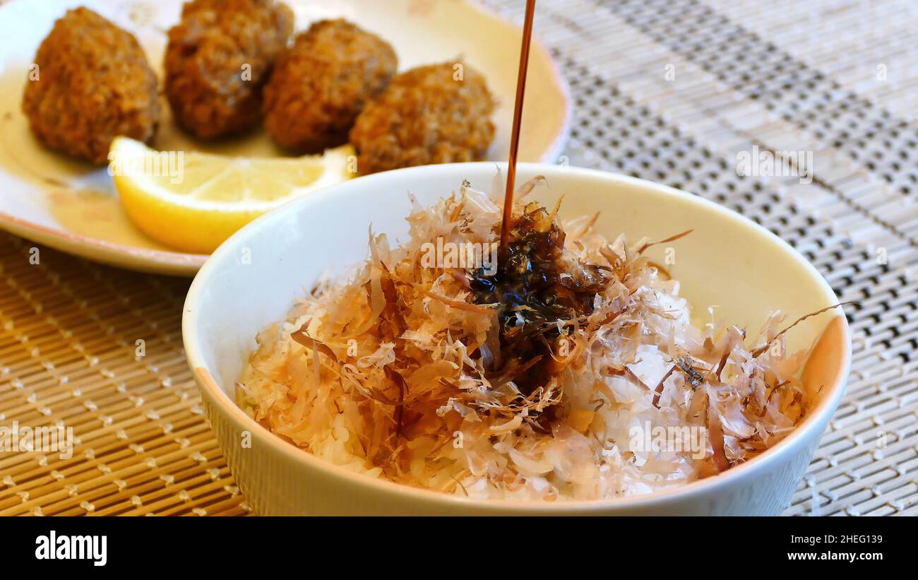 Putting the Dried Skipjack Tuna over the rice to make the traditional ...