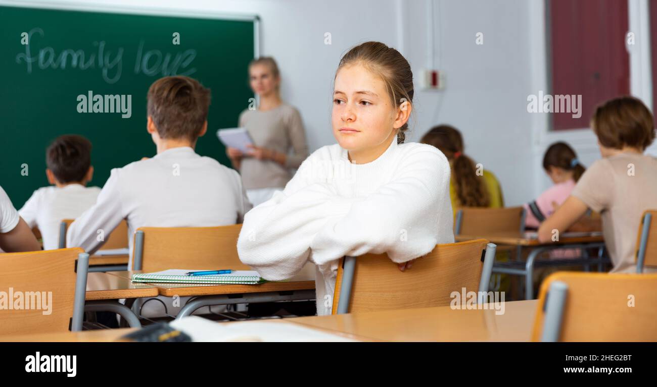 Sad teenage girl in classroom during lesson Stock Photo - Alamy