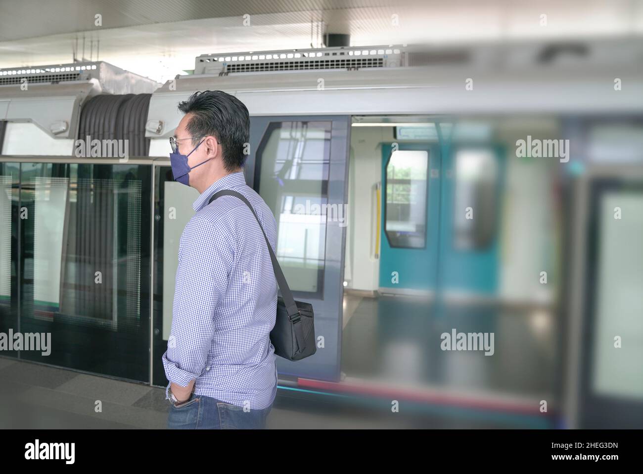 Asian man commuter with face mask on walking out from subway train to ...