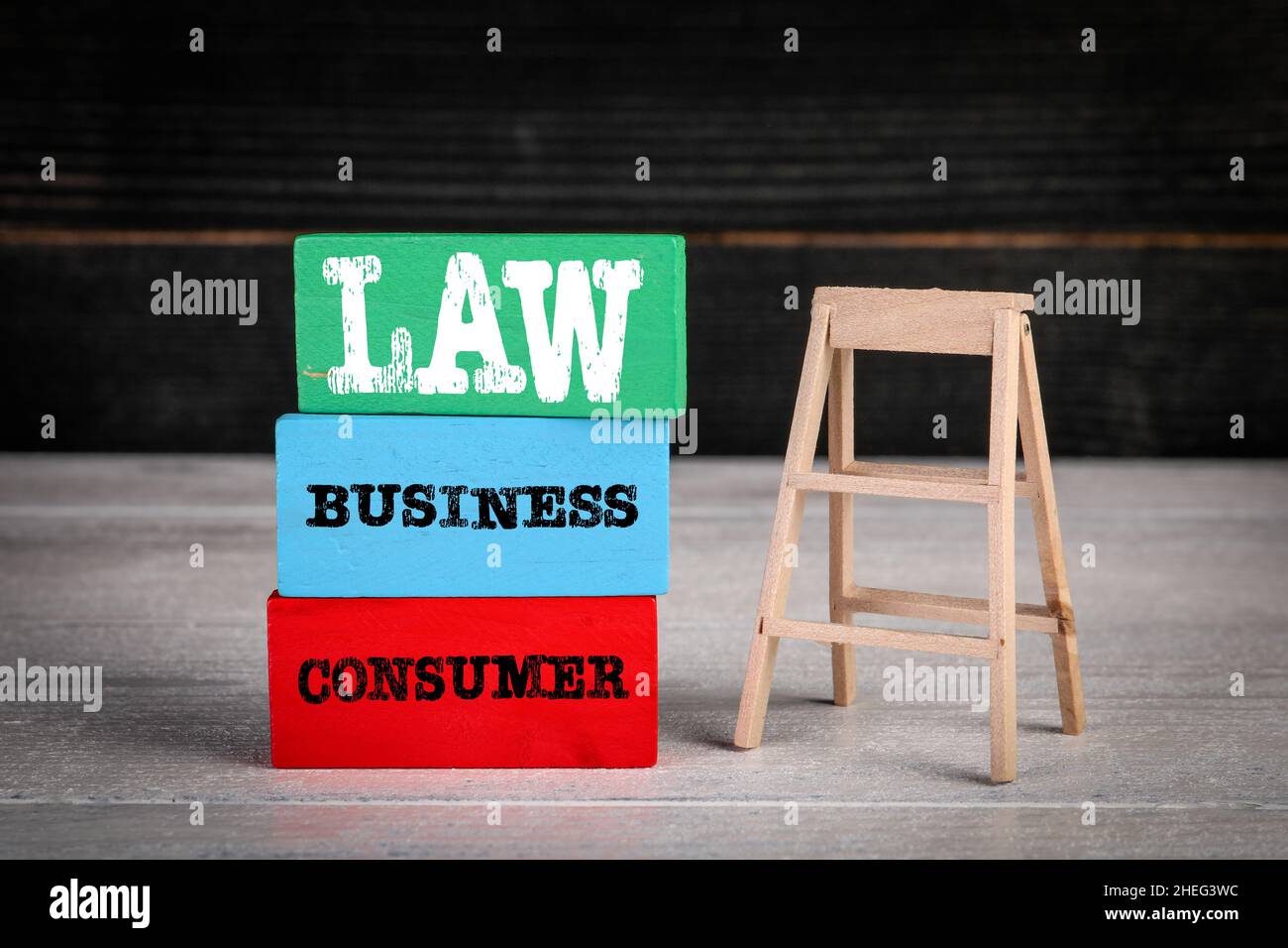 Consumer and Business Law concept. Colored wooden blocks in a pile and ...