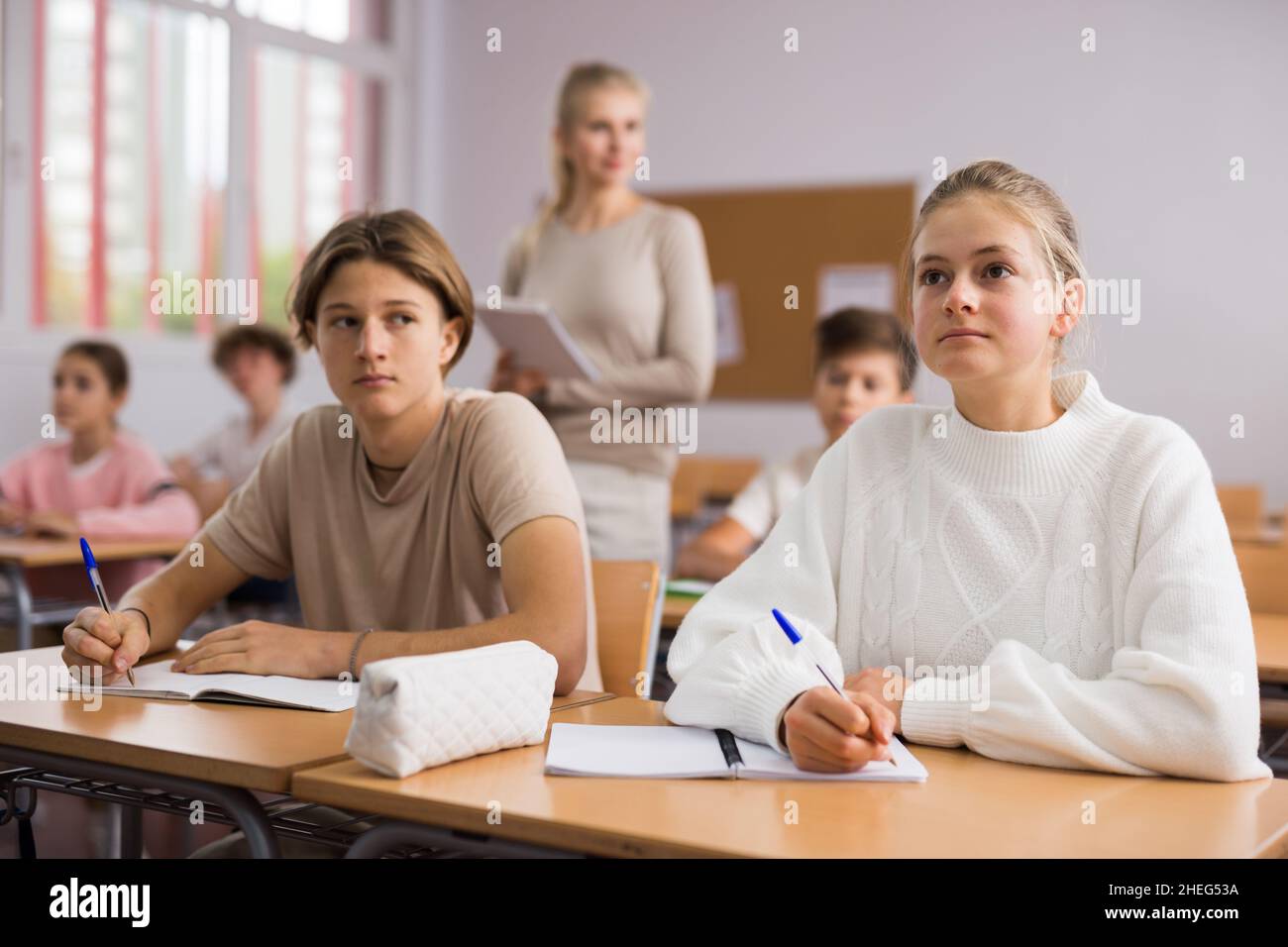 Teenagers doing tasks during lesson in school Stock Photo - Alamy