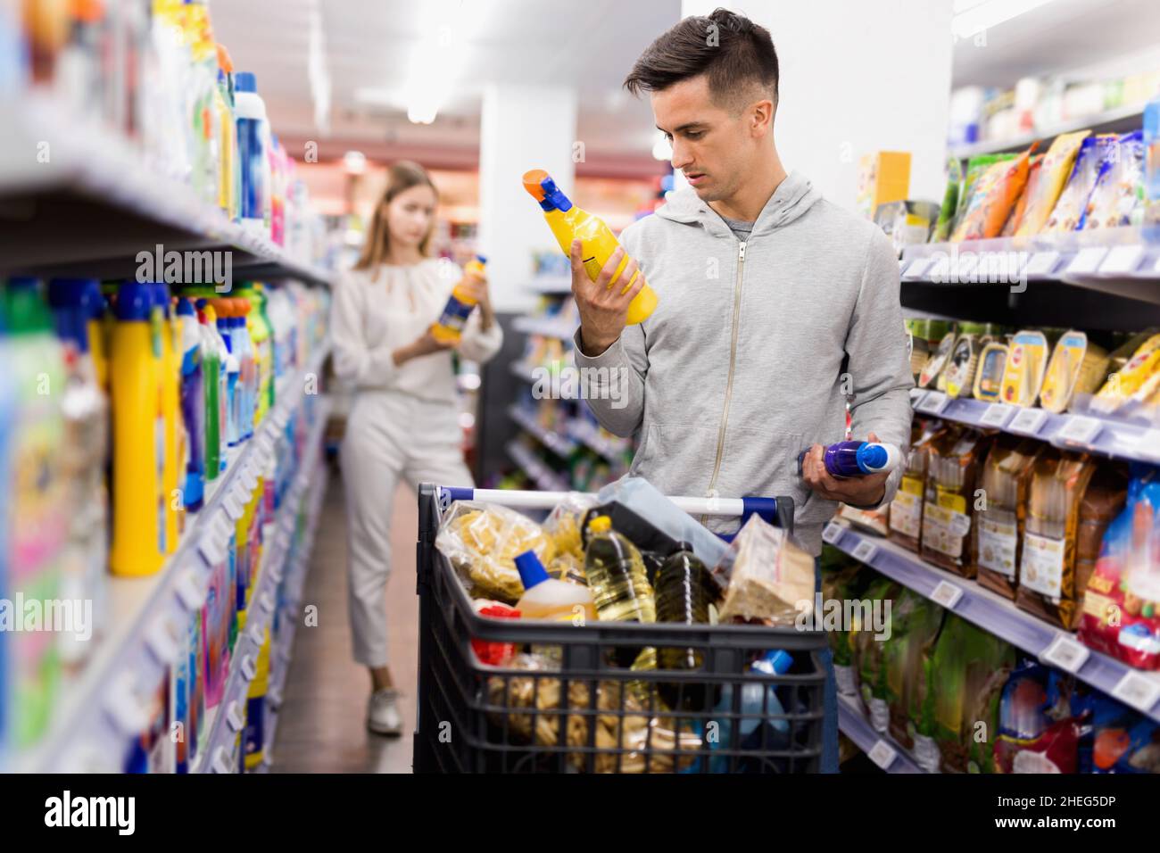 Serious young customer choosing goods hi-res stock photography and ...