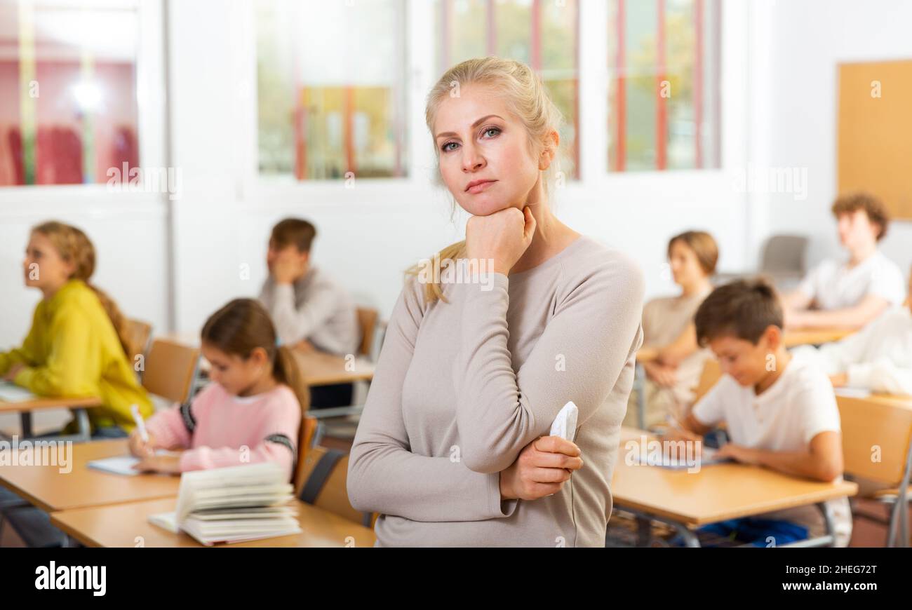 Portrait of thoughtful teacher in classroom Stock Photo - Alamy