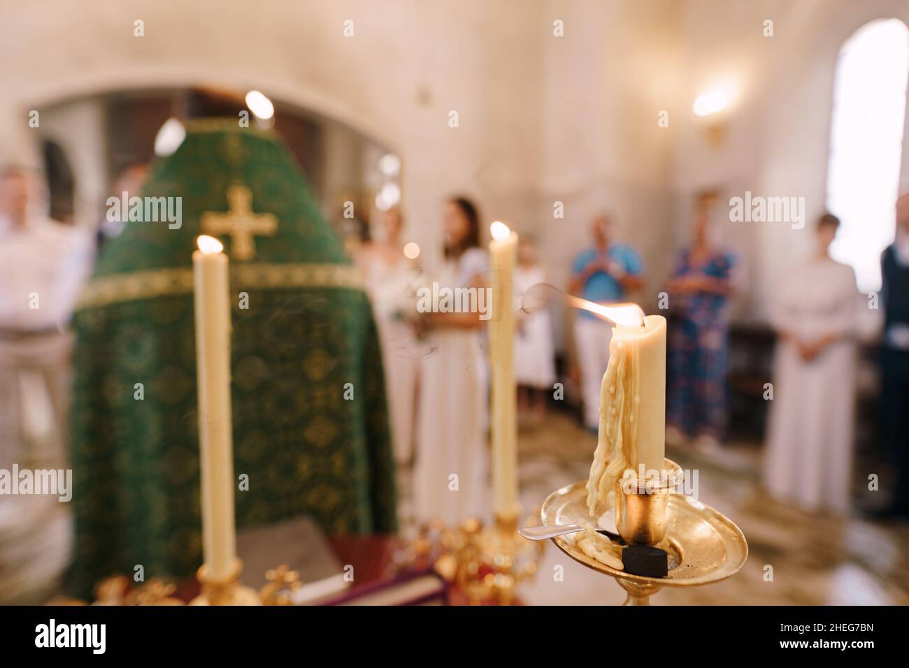 Candles burn during a wedding ceremony in a church Stock Photo - Alamy