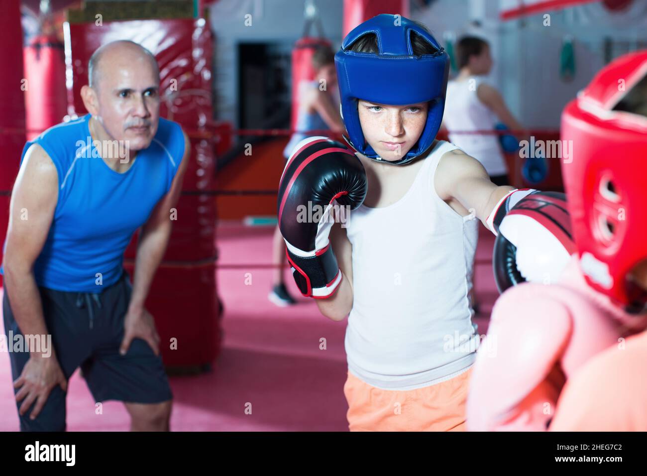 Boys sparring at boxing workout with coach Stock Photo - Alamy