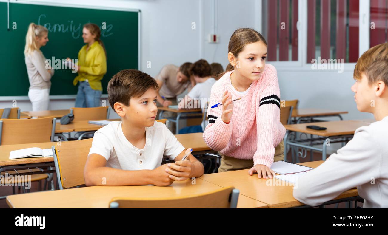 Pupils performing group tasks in classroom Stock Photo - Alamy
