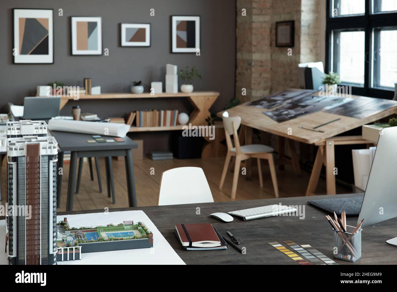 Large workshop of architects with house layout, desktop hardware ...