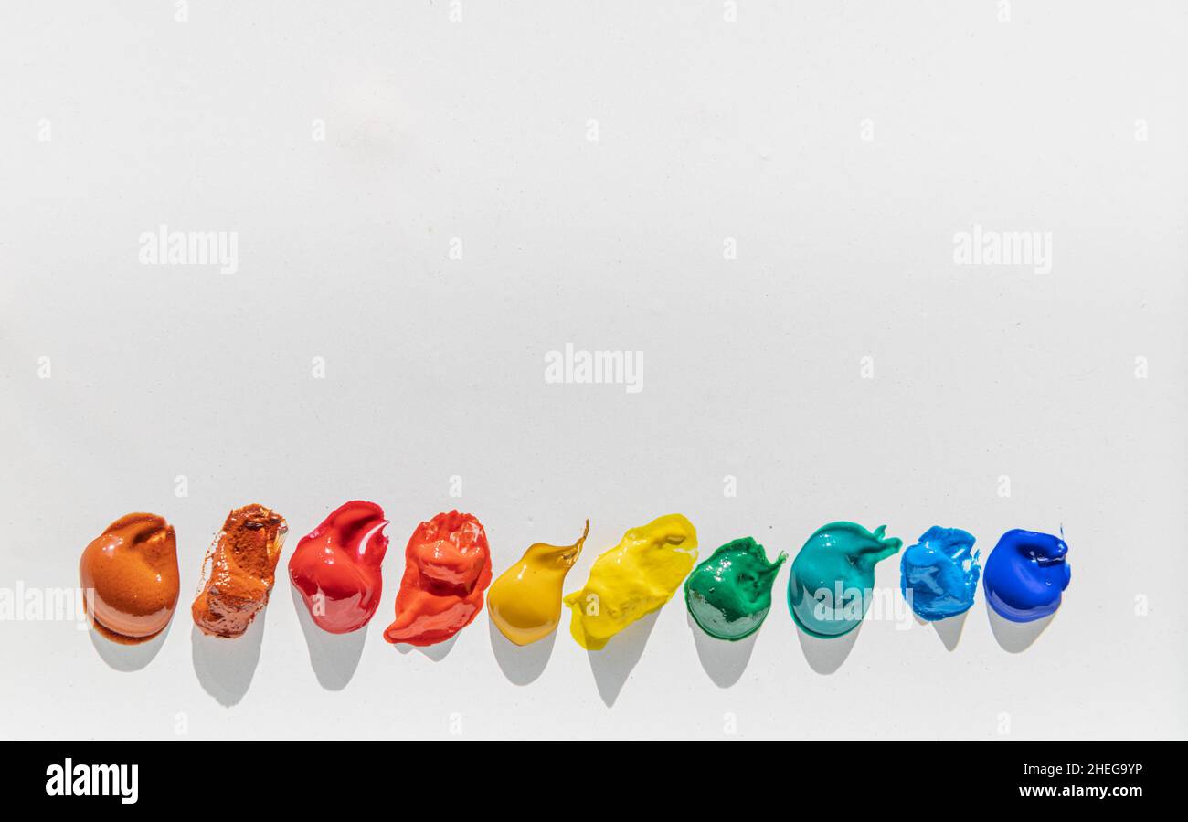 Paint in colors of rainbow on bottom of white background with text ...