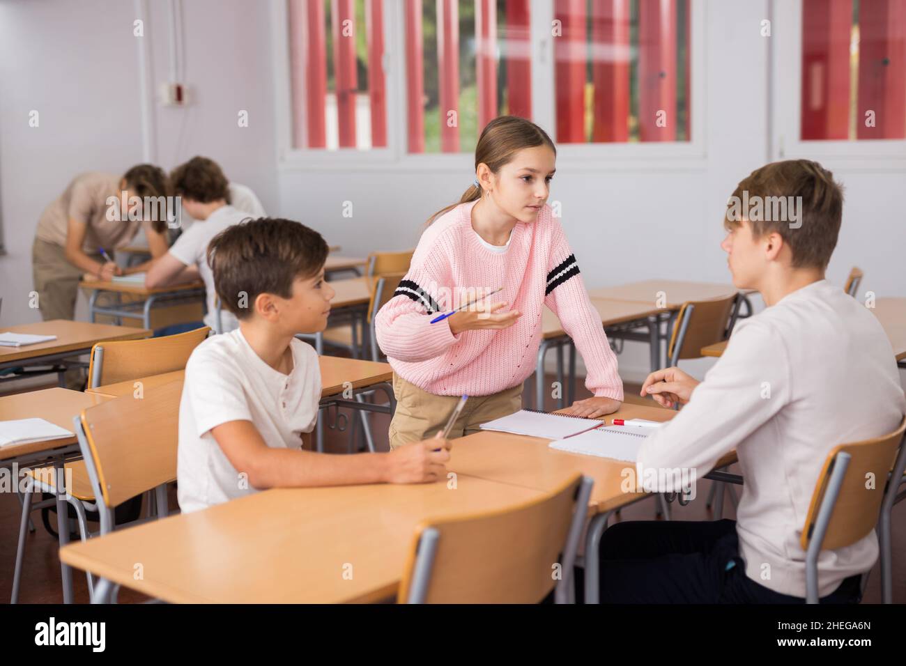 Pupils performing group tasks in classroom Stock Photo - Alamy