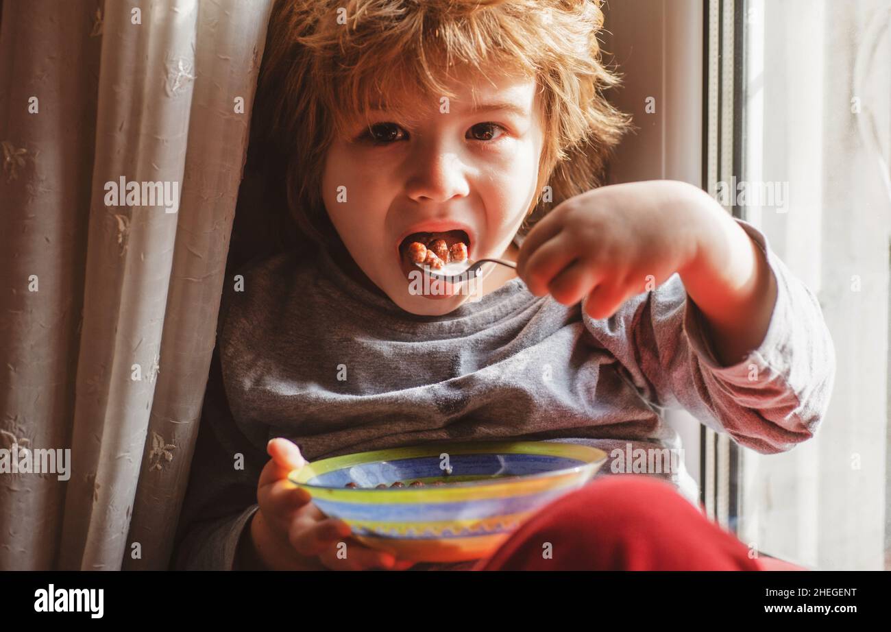 Hungry kid eat. Child eating healthy food. Cute little boy having soup for lunch. Healthy ...
