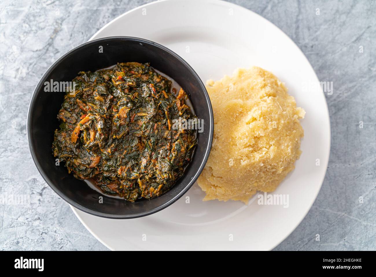 Nigerian Spicy hot Vegetable soup served with Eba or Garri Stock Photo ...