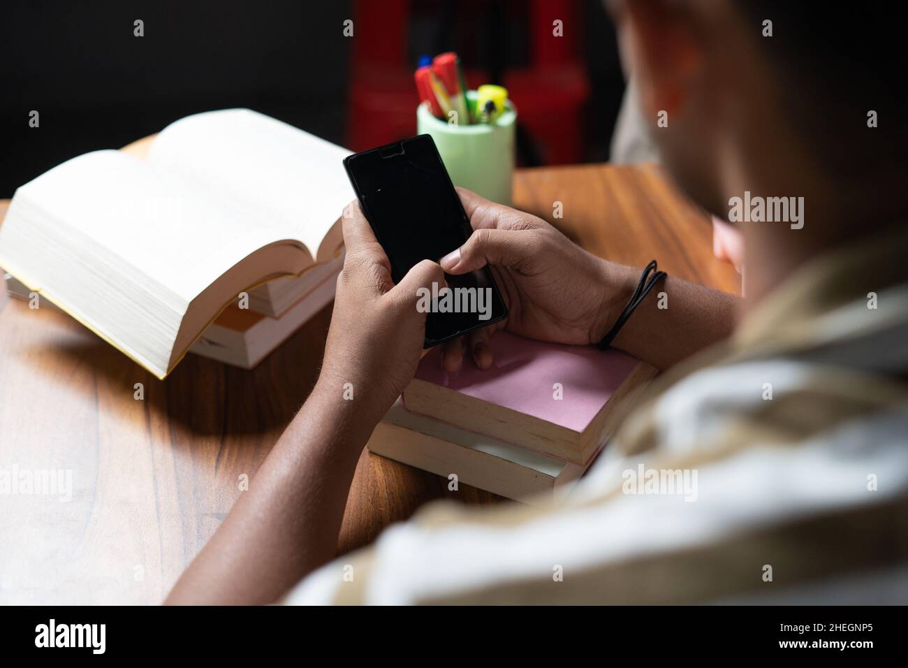 Focus on mobile unrecognizable Young studnet using or chatting on ...