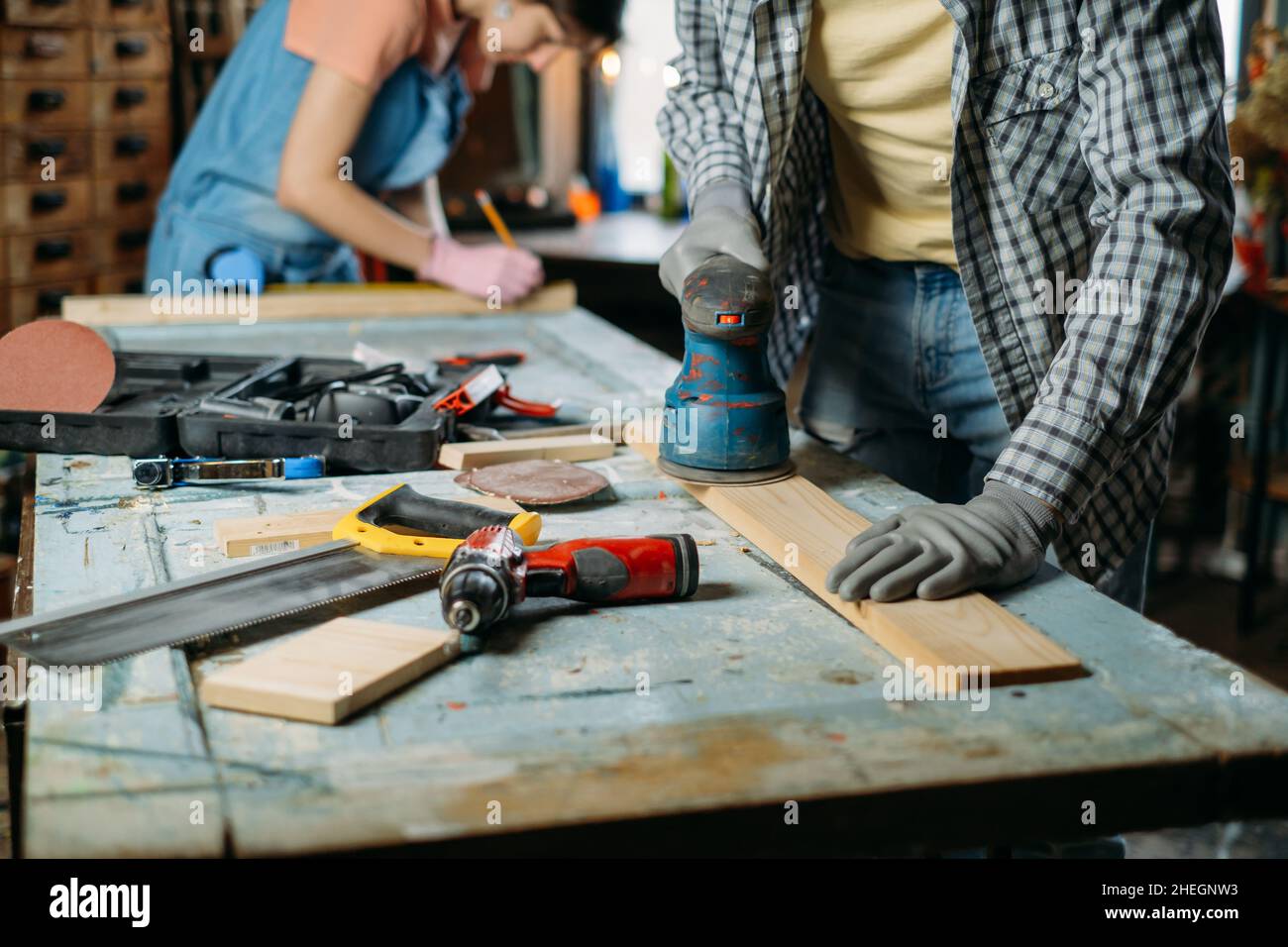 Man and woman working in workshop, doing furniture, reuse old materials ...