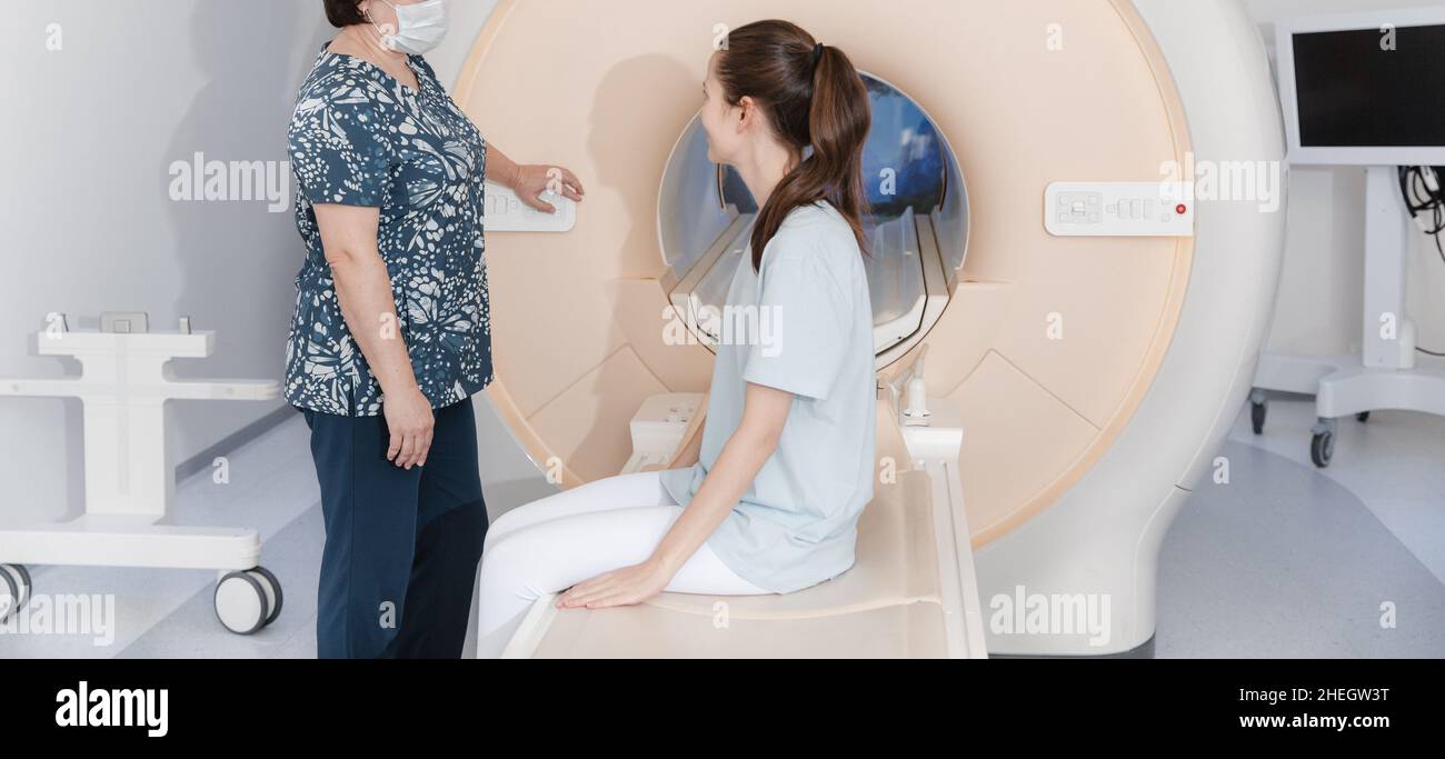 Doctor or nurse and patient with tomography CT or MRI Scan in hospital ...
