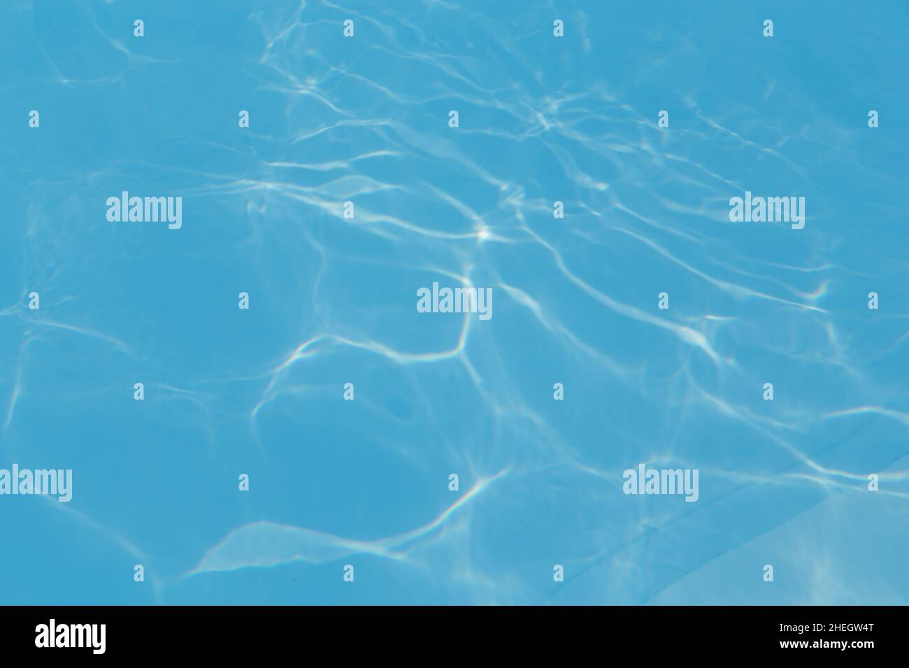 Blue pool water with sun reflections background Stock Photo - Alamy