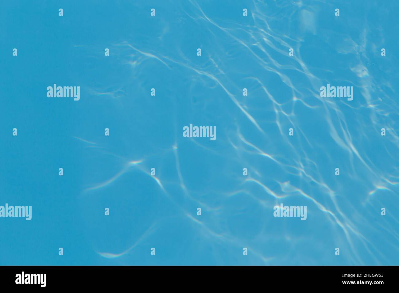 Blue pool water with sun reflections background Stock Photo - Alamy