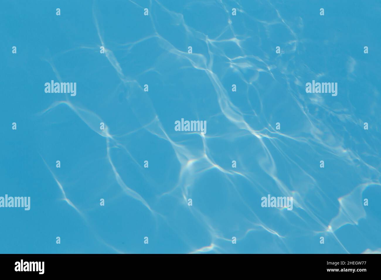 Blue pool water with sun reflections background Stock Photo - Alamy