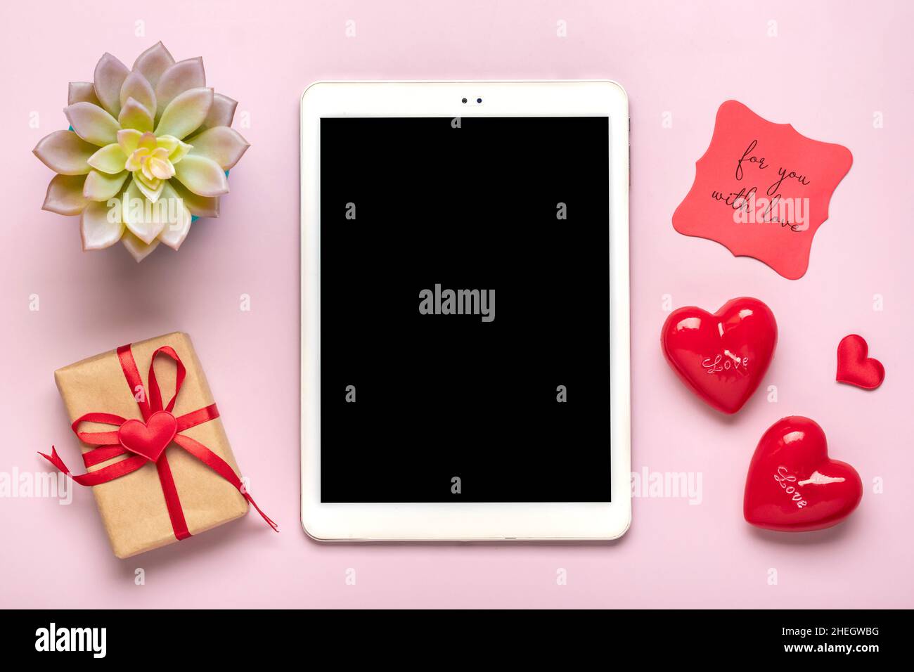 digital tablet for chooses gifts, makes purchase, envelope, red hearts ...