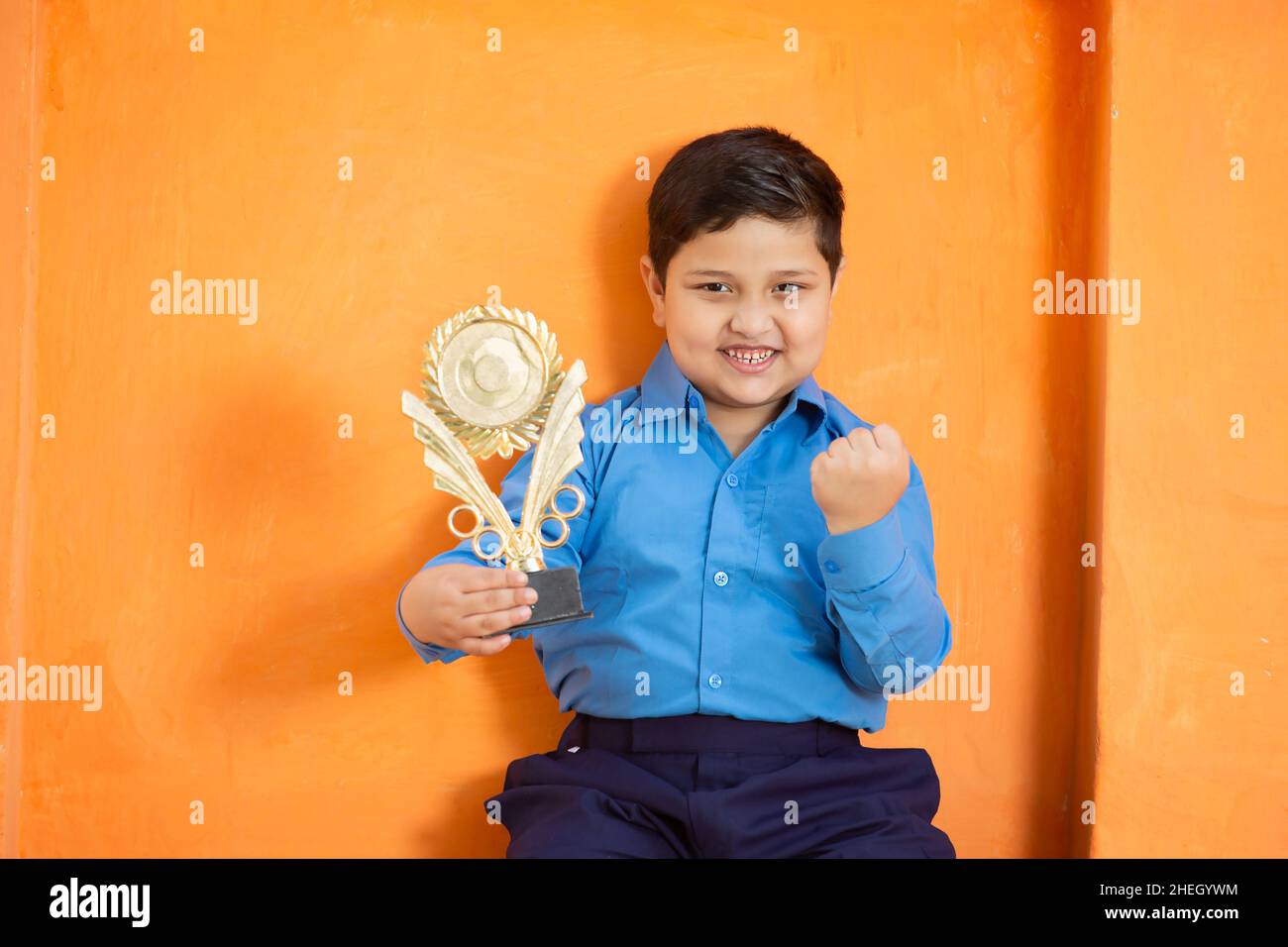 Happy adorable cute indian boy in school uniform celebrating victory ...