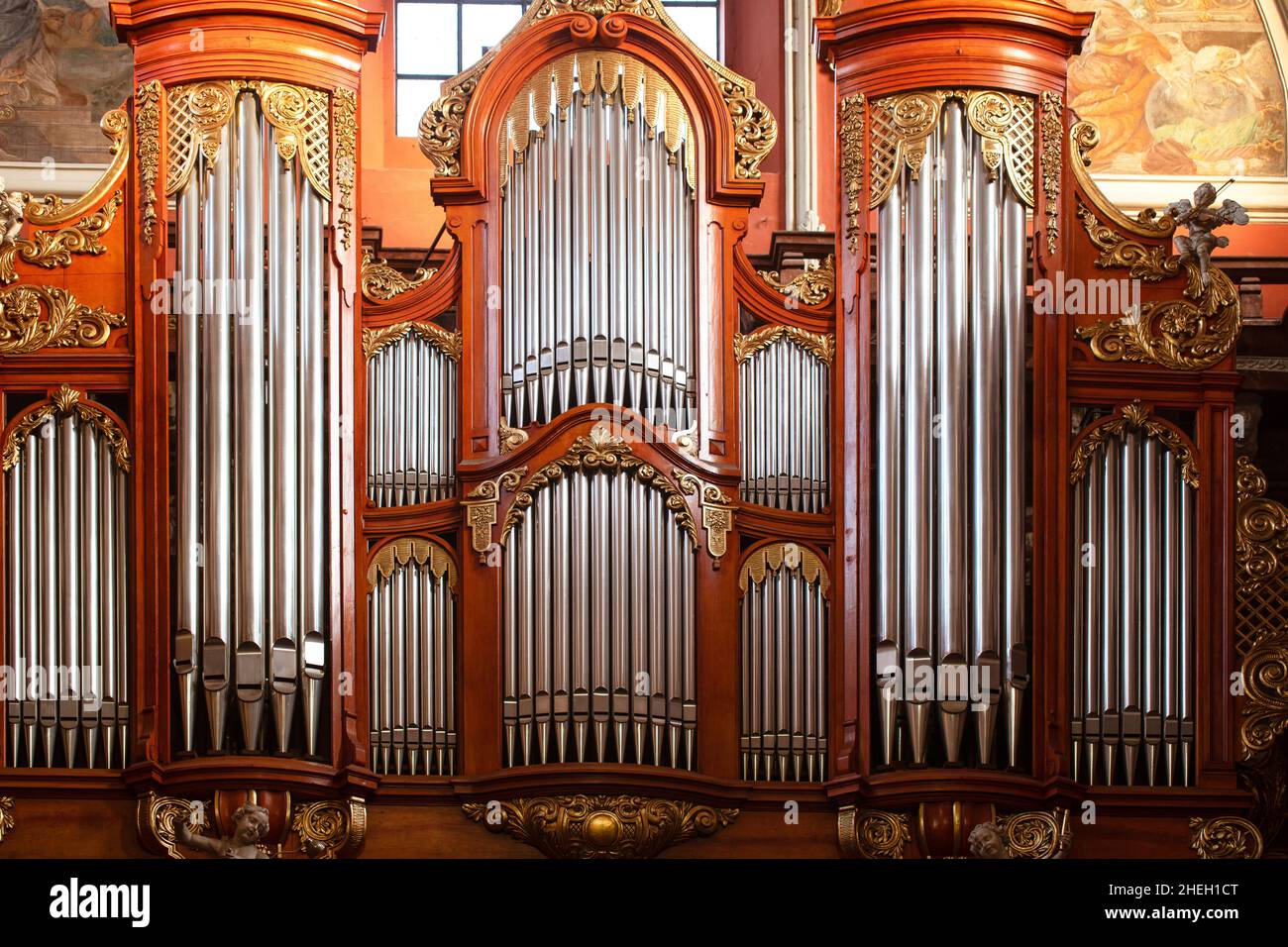 The organ in the Baroque parish church in Poznan, Poland. Fragment of ...