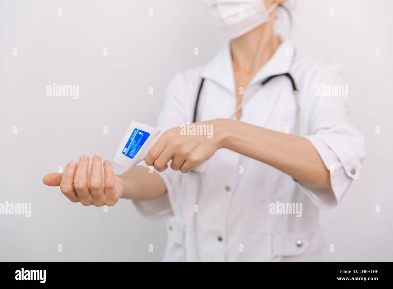 Temperature measurement gun in doctor hands. Close-up shot of doctor ...