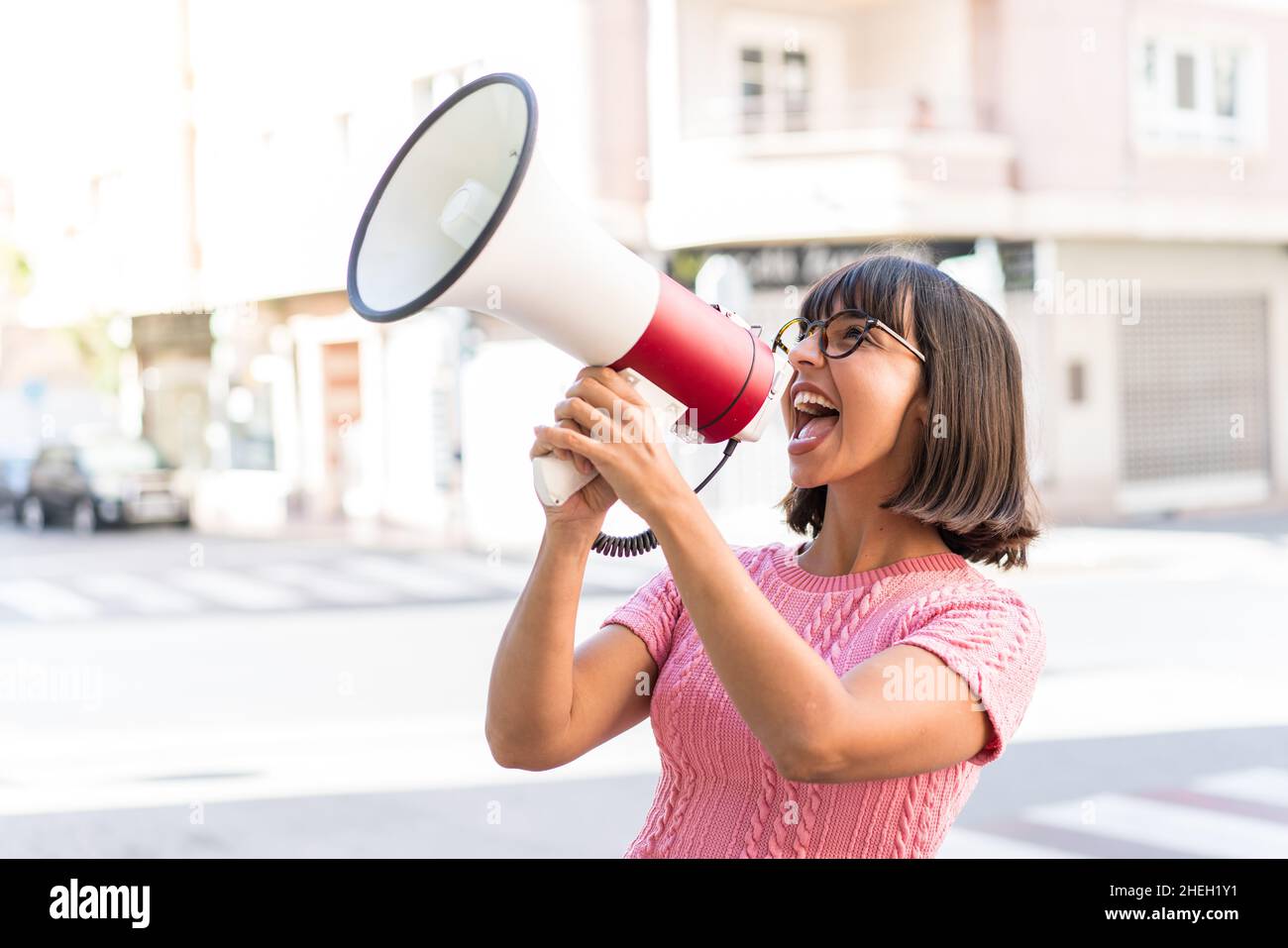Woman speaking through megaphone in hi-res stock photography and images ...